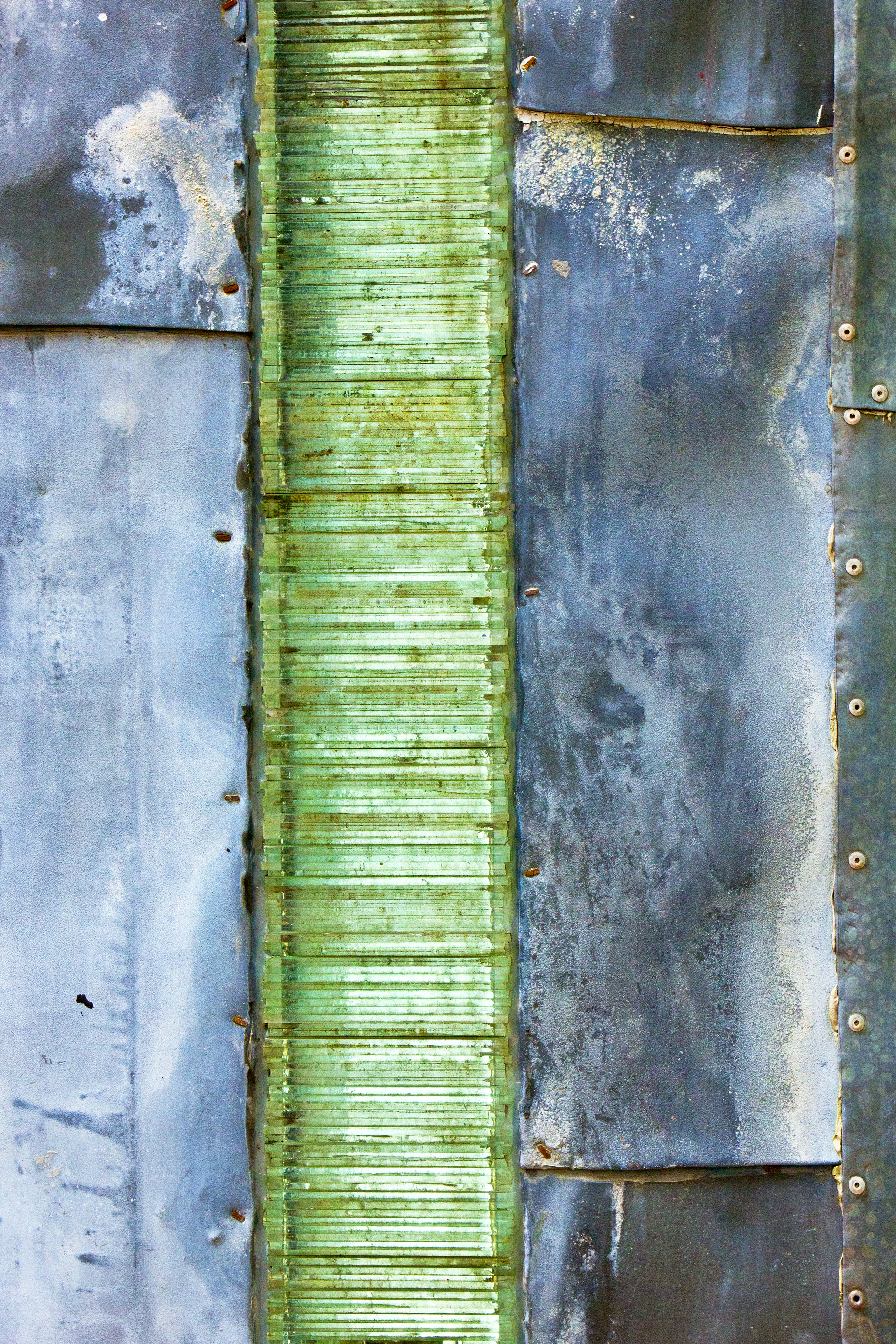 Verdigris Ribbon: Weathered Steel Panels Framed by a Green Ribbed Stripe