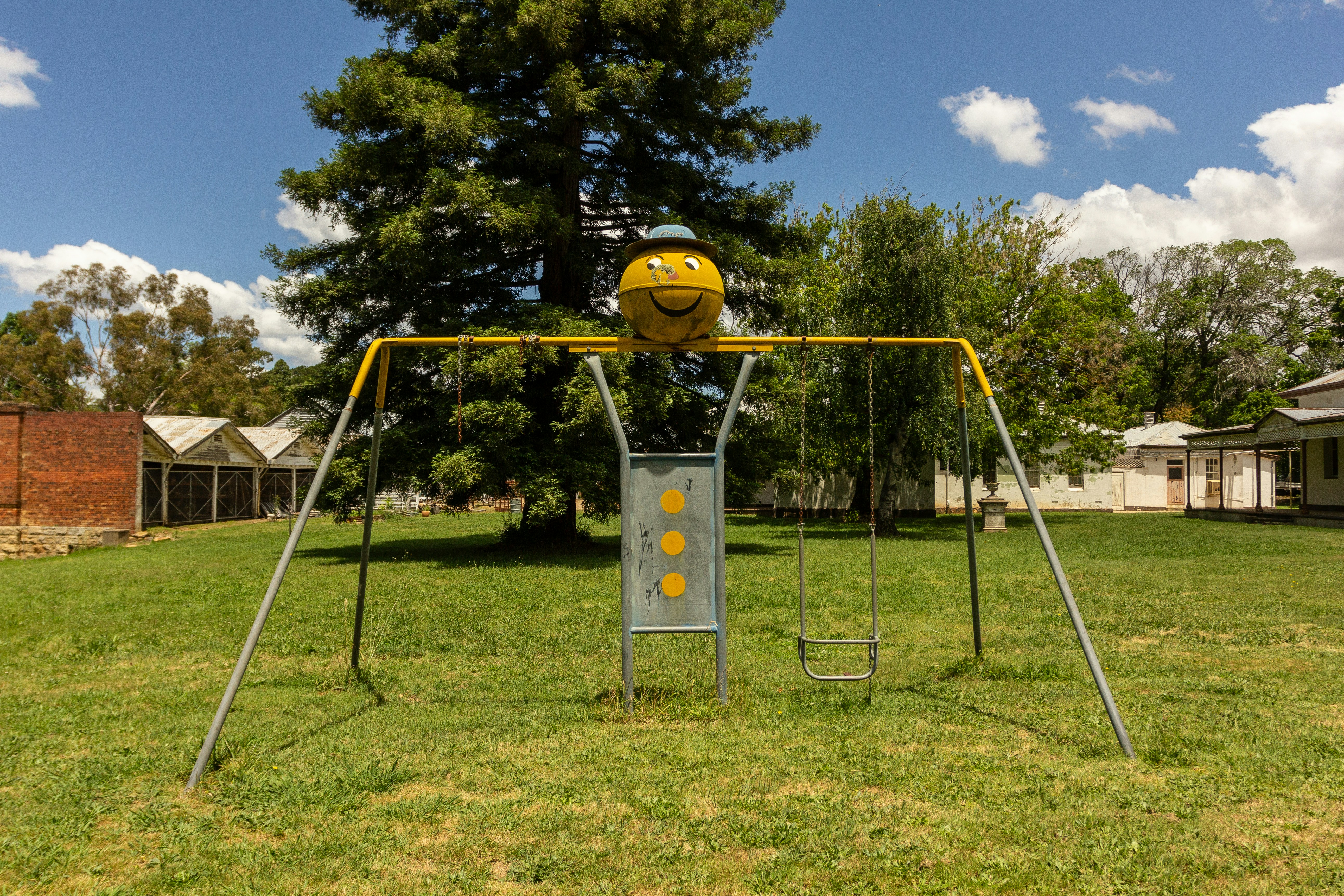 Sunny Smile Over the Swing Set: A Cheerful Playground Centerpiece