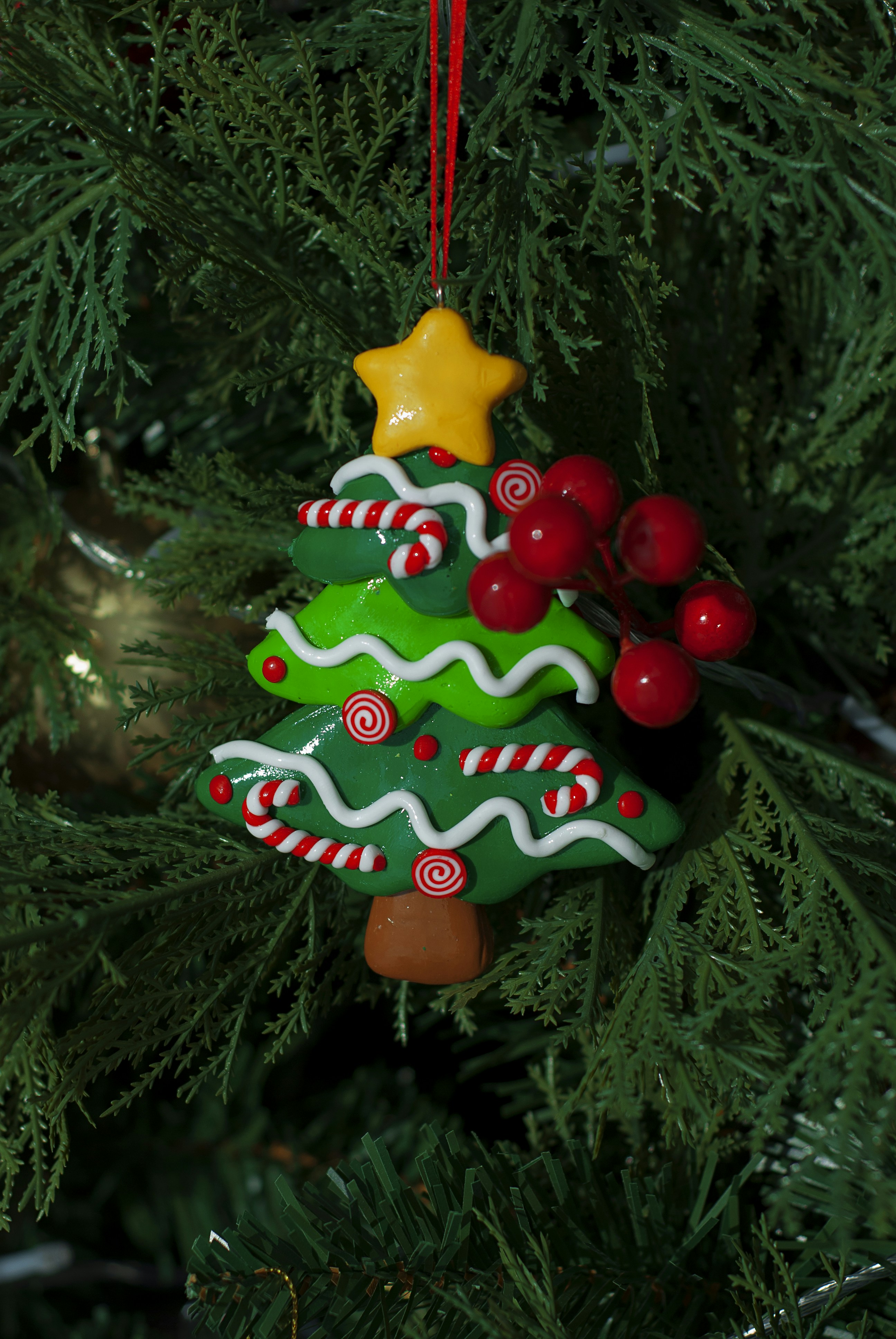 Emerald Christmas Tree Ornament Adorned with Candy Canes and Red Berries