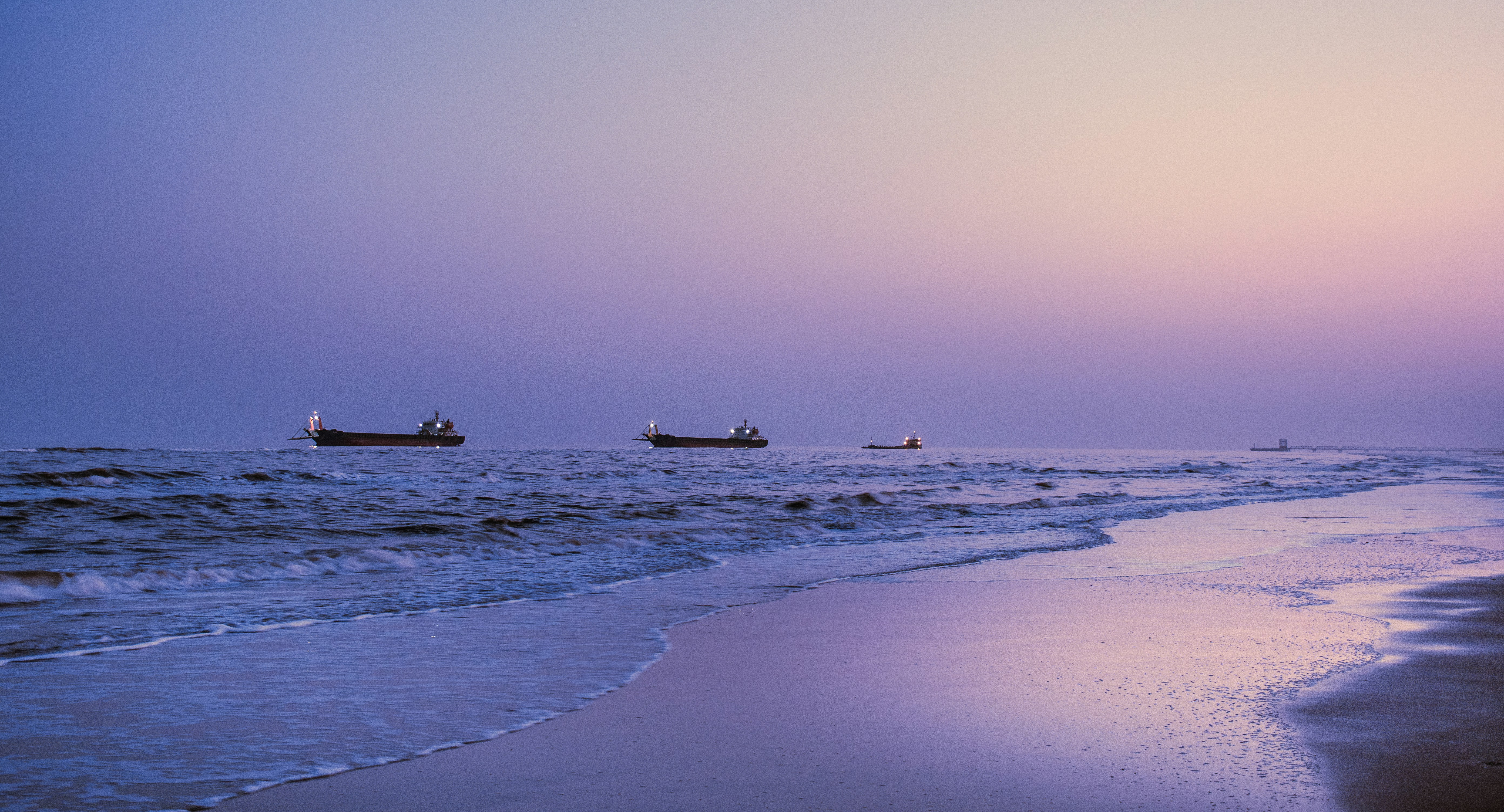 Dusk Drift: Three Boats Trace a Lavender Horizon