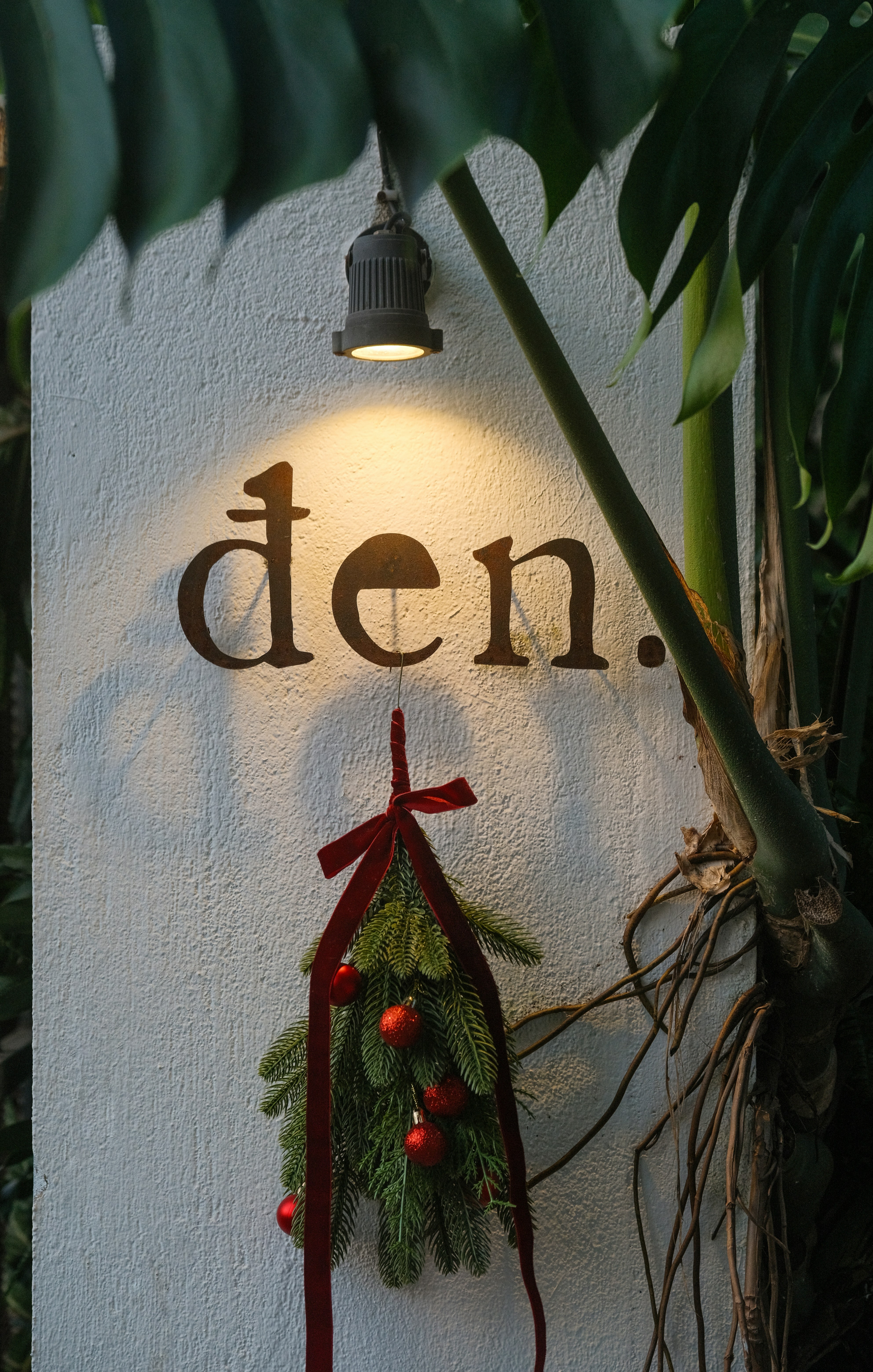 A sign that says den hanging on the side of a building photo – Free ...