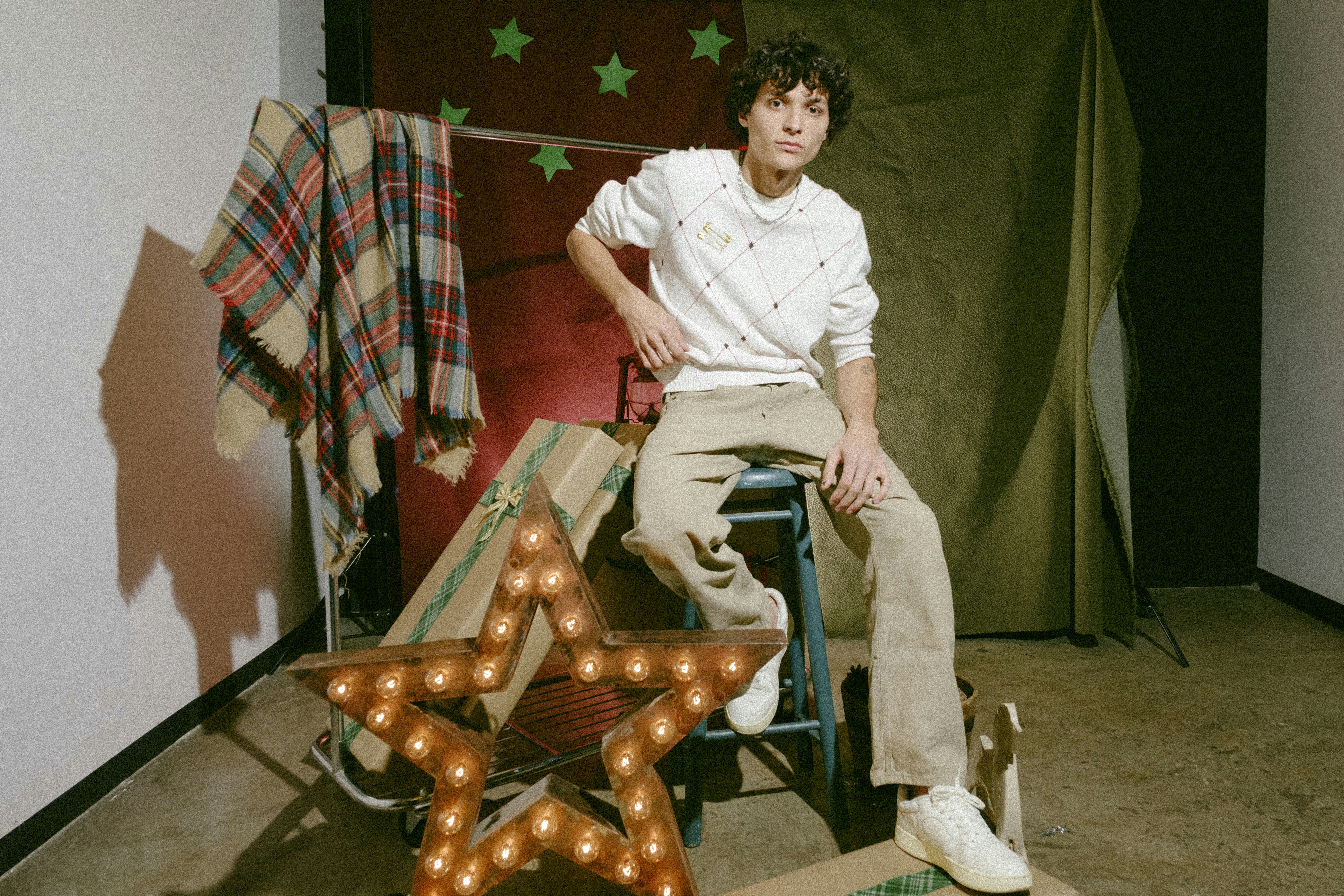 A man sitting on a chair with a star on the floor photo – Free Luxury ...