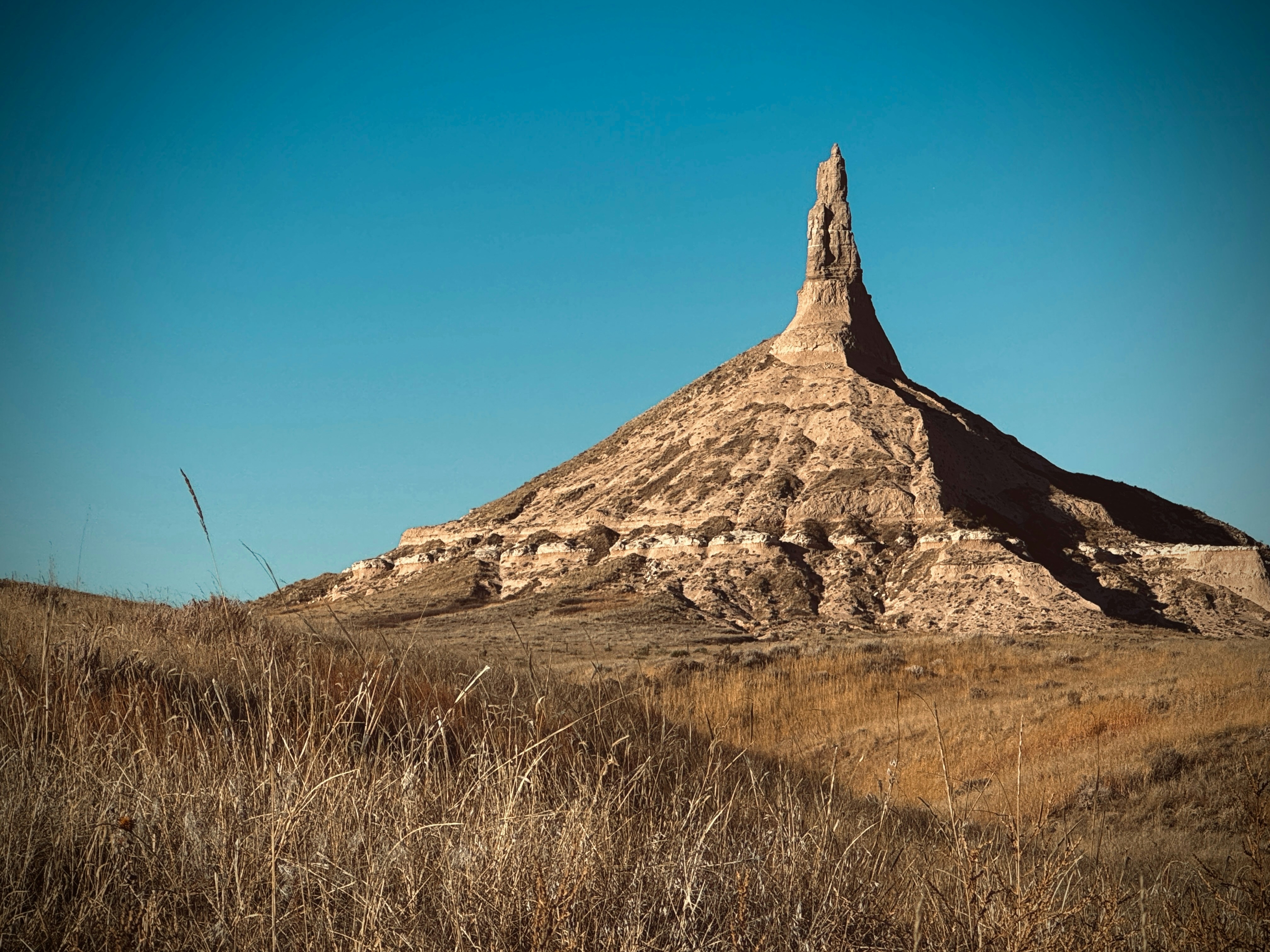 A very tall mountain in the middle of a field photo – Free Nebraska ...