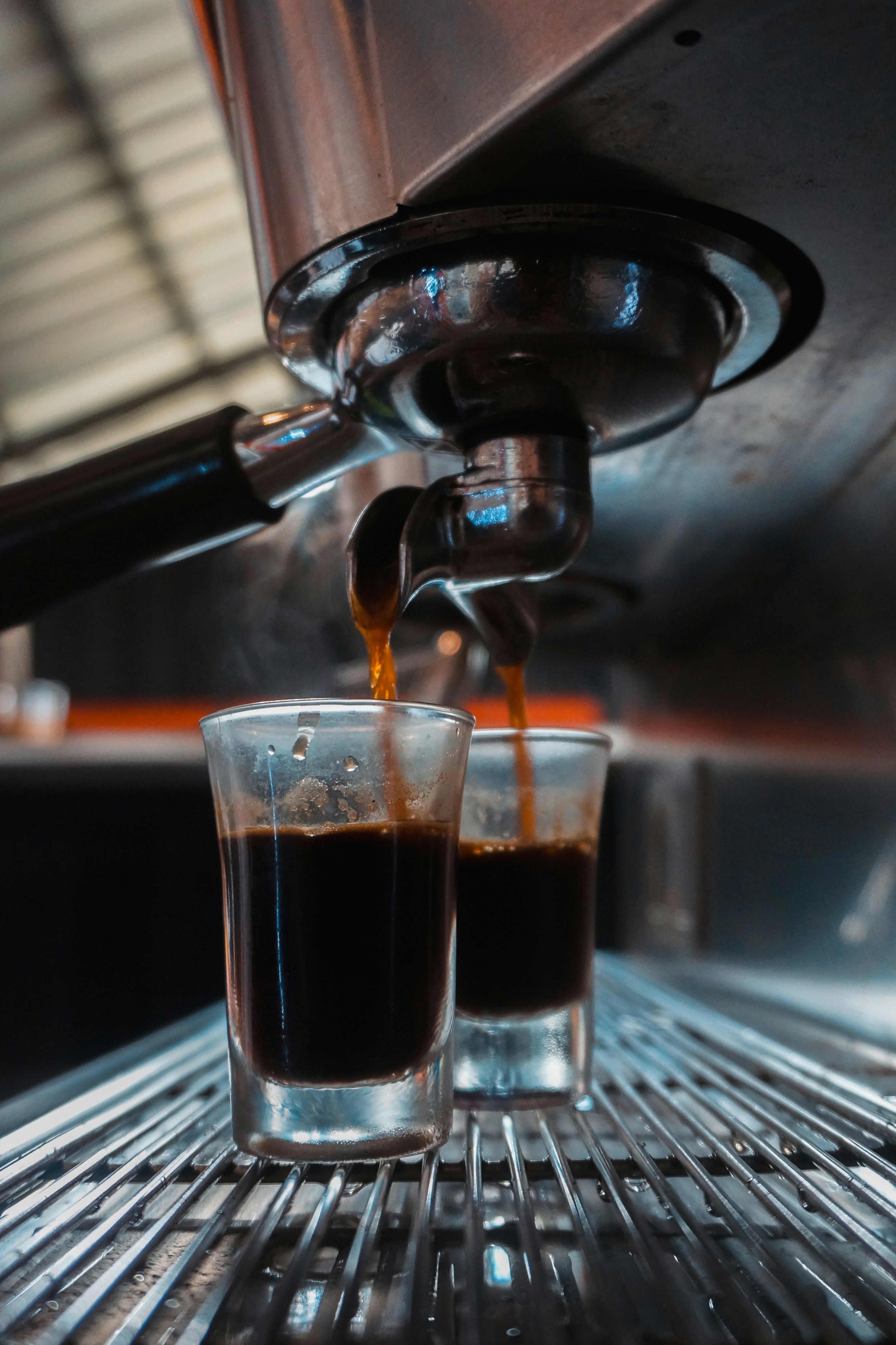 Copper Streams Beneath the Portafilter: Espresso Pour Into Twin Glasses