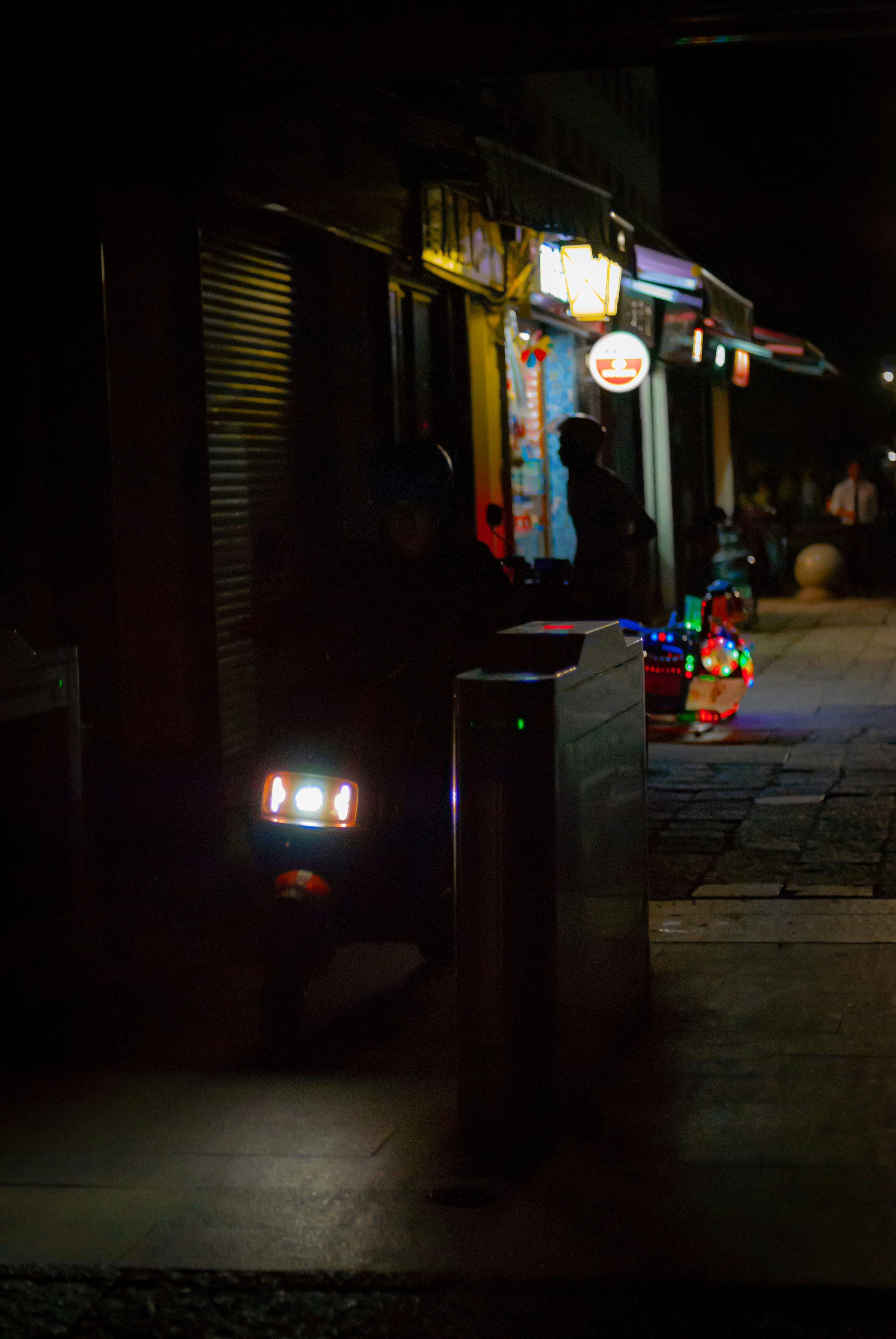 Night Market Scooter Glow: A Quiet Street Scene Under Neon Light