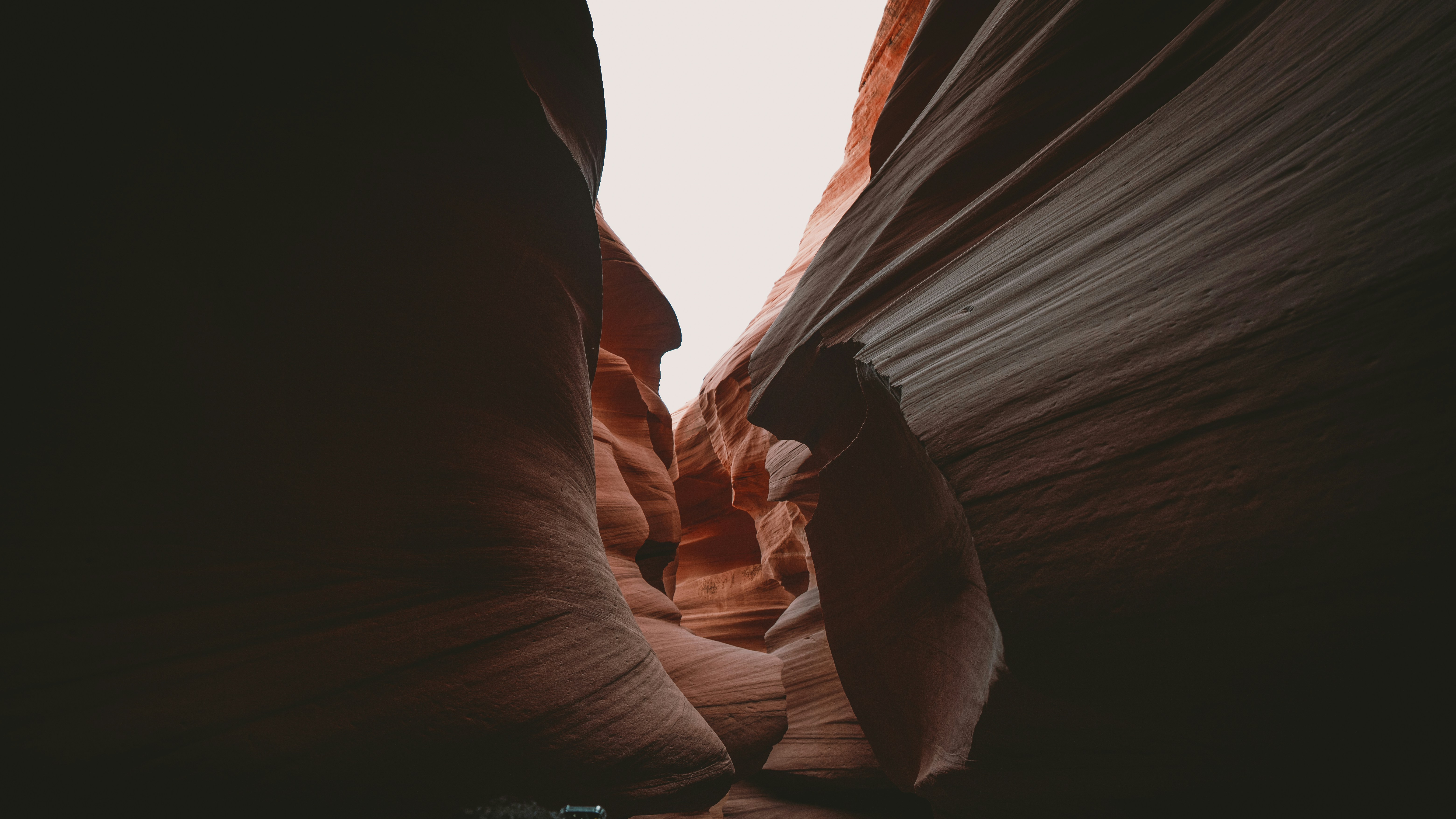 A person standing in a narrow slot in a canyon photo – Free Wallpaper Image on Unsplash