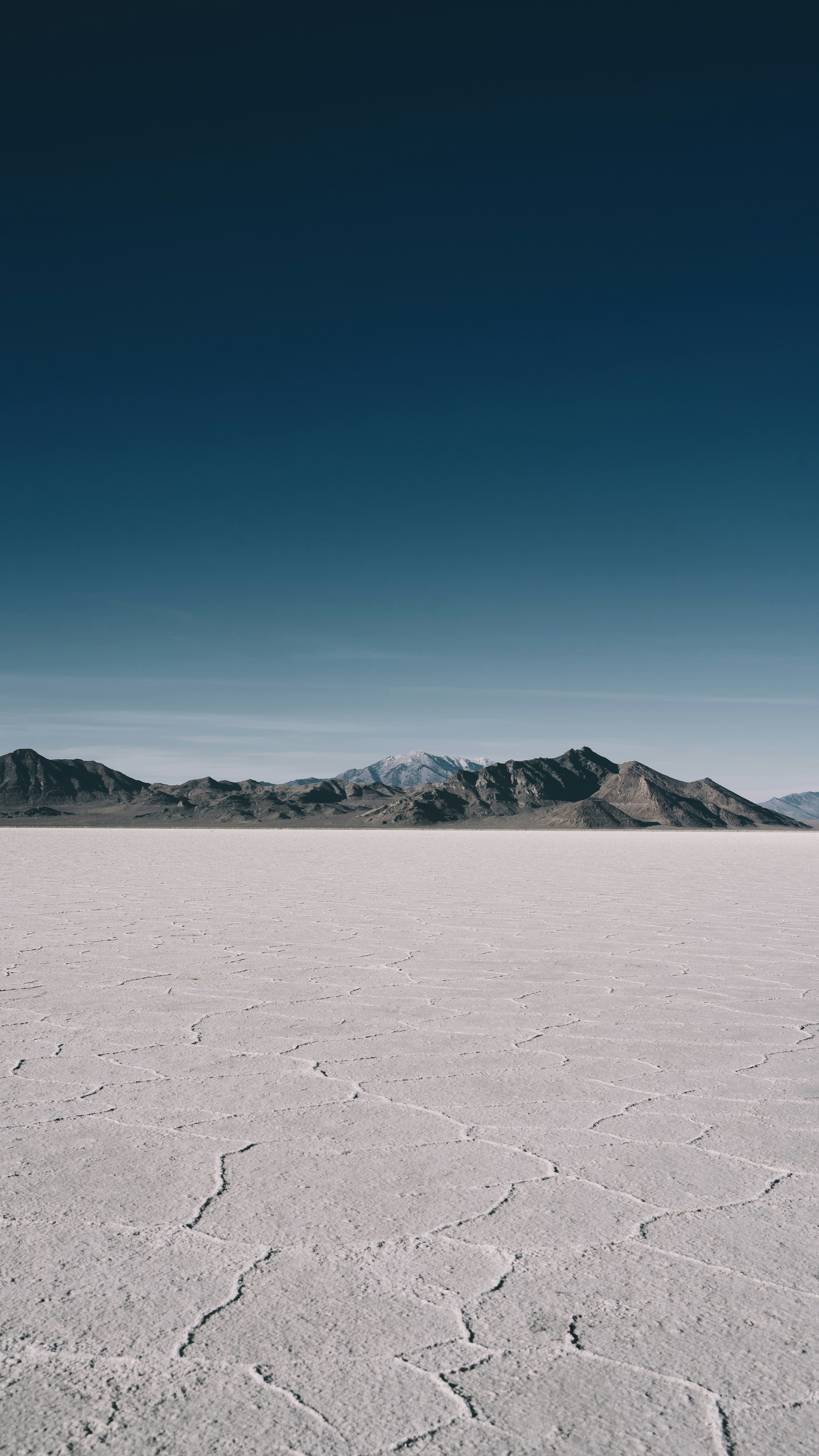 A vast expanse of flat land with mountains in the distance photo – Free ...