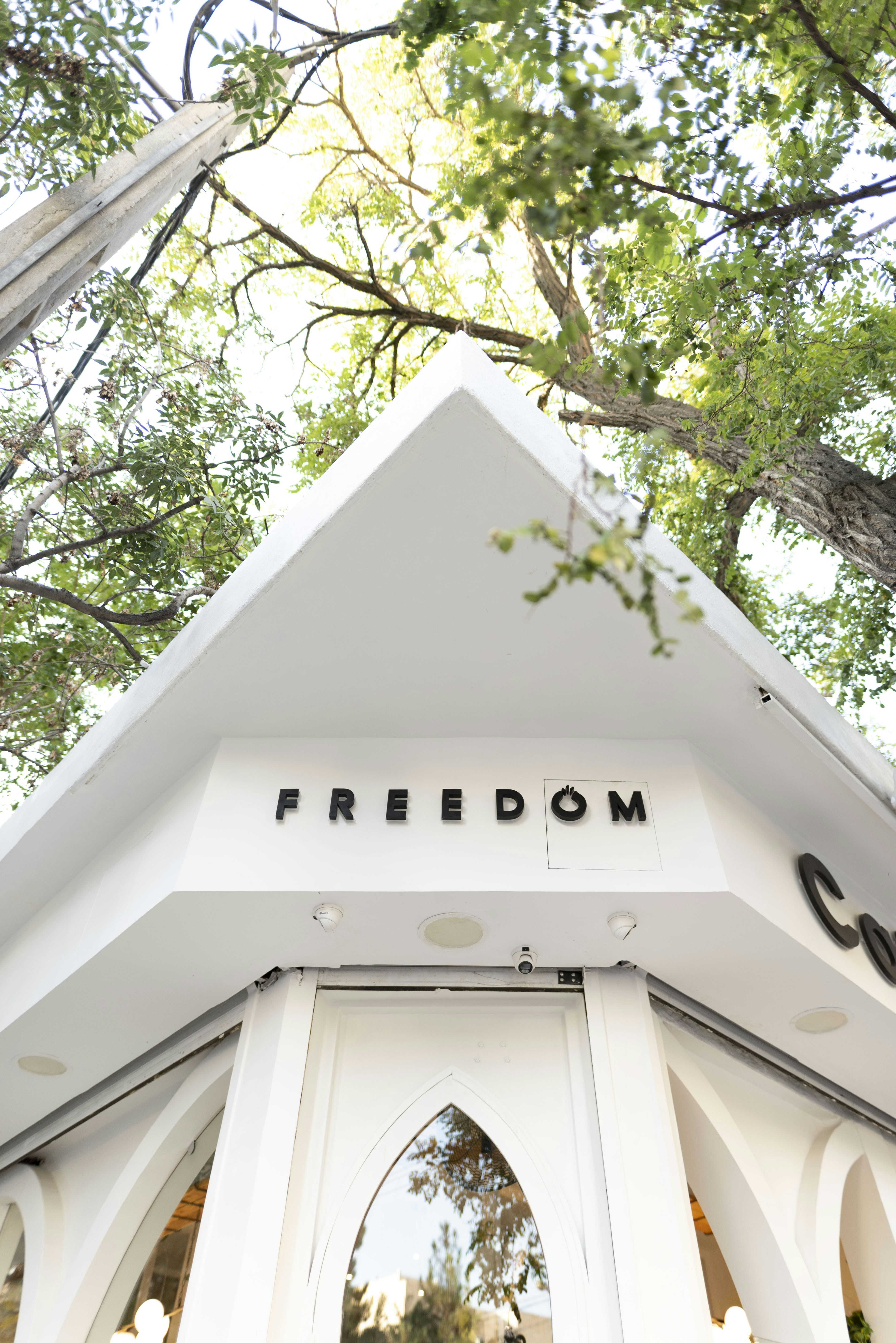 Gateway of Freedom: Archway Sign and Verdant Canopy