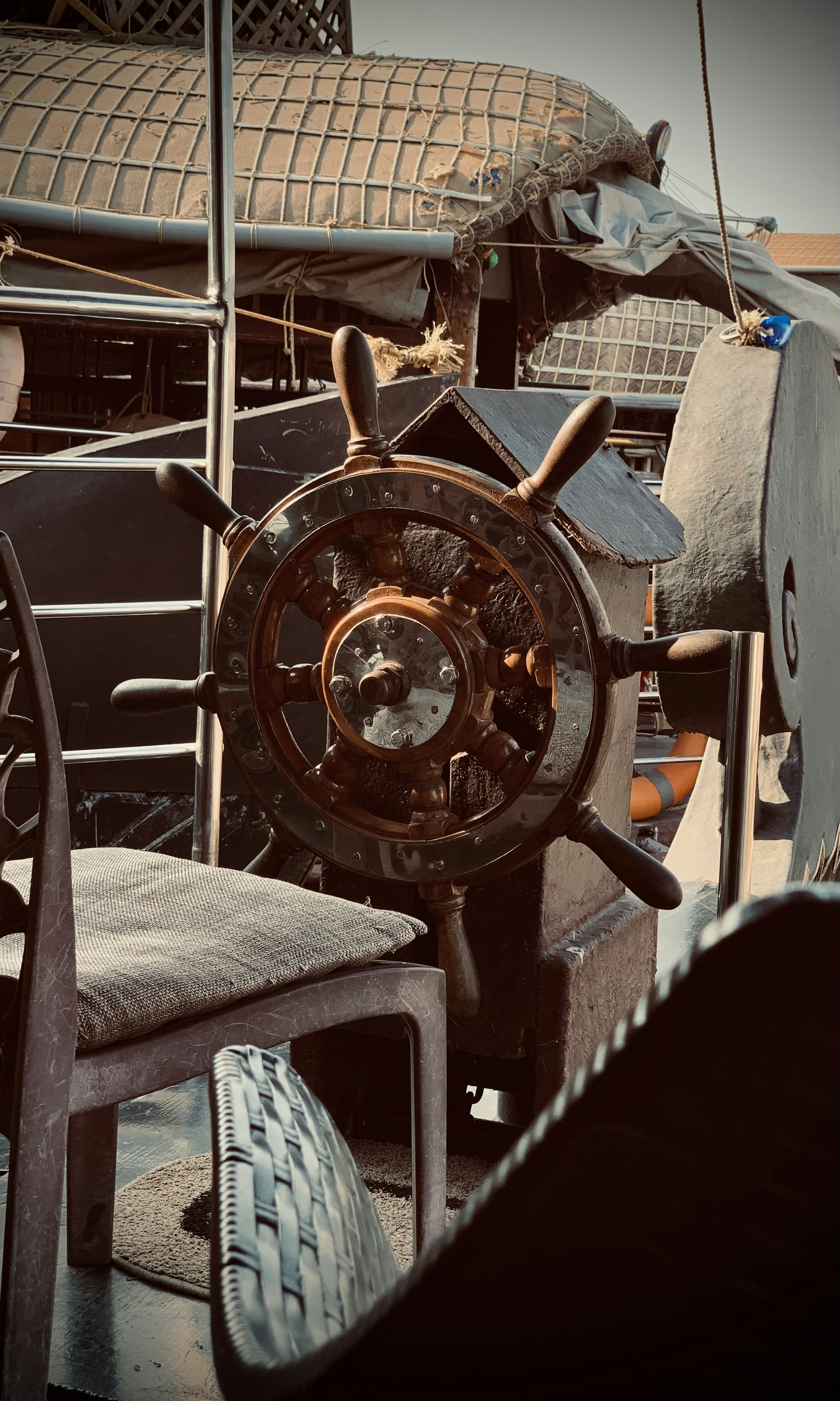 Bronze Helm at Dusk: a Weathered Ship's Wheel in Focus