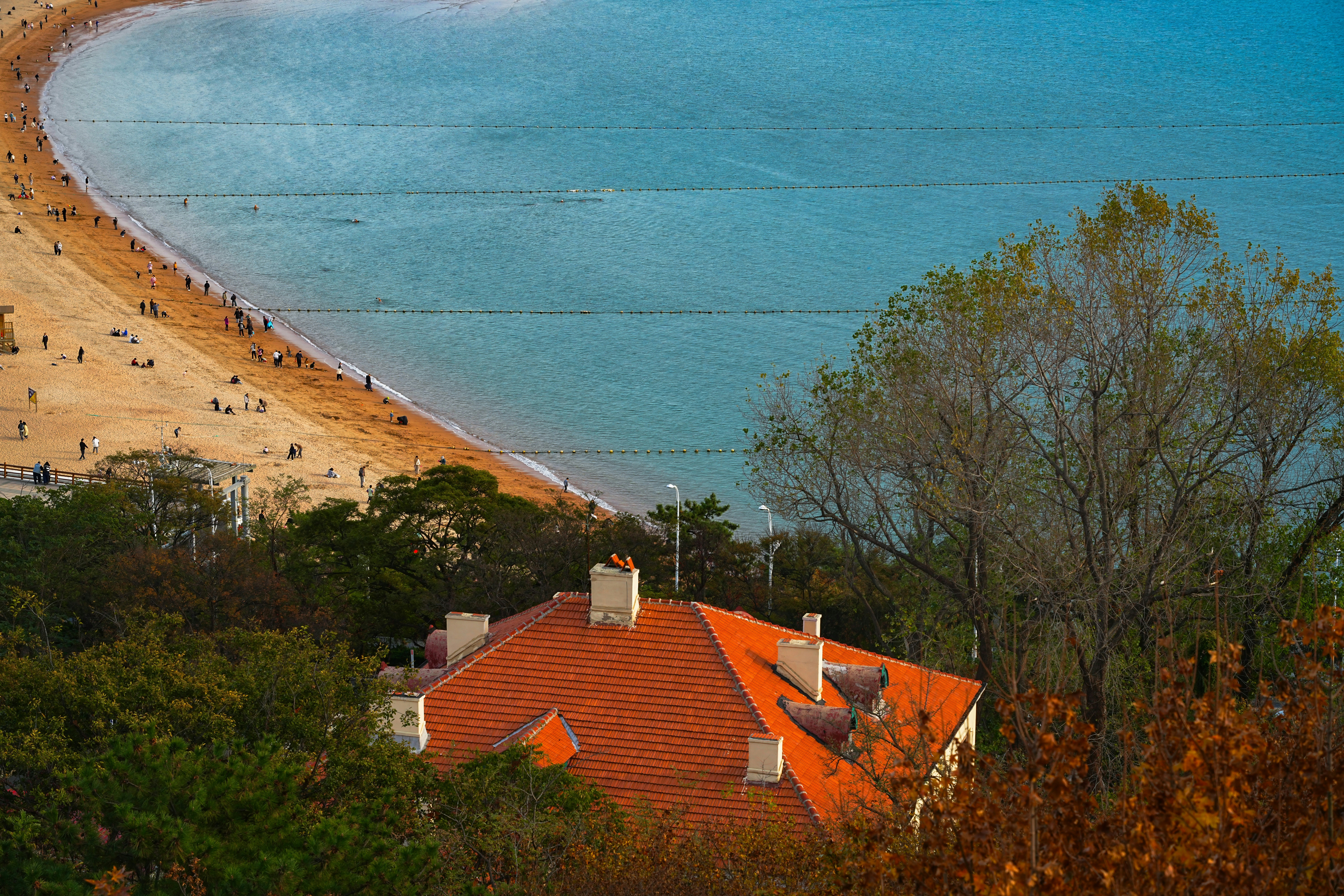 Red-Tiled Rooftops Framing a Turquoise Bay