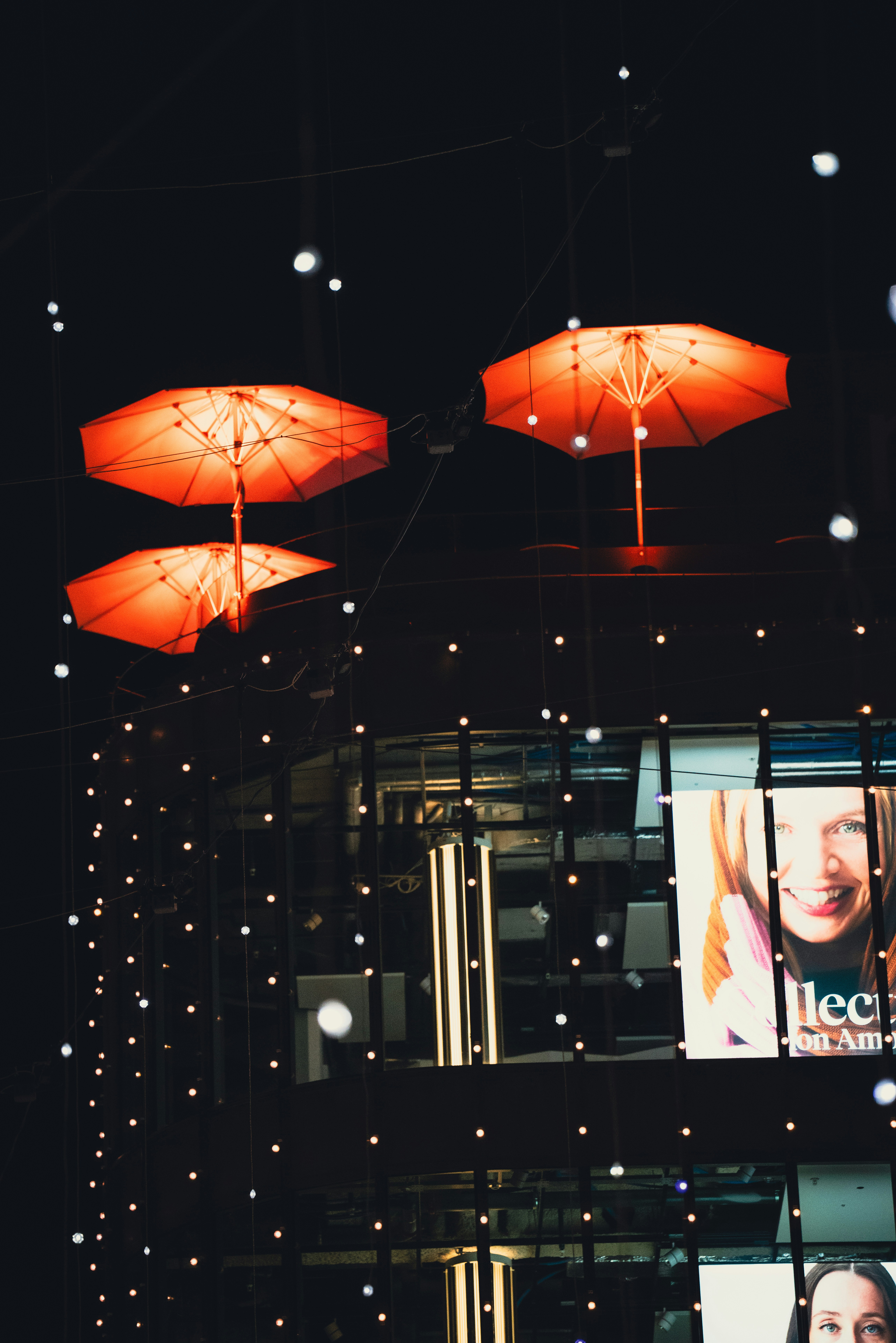 A building with umbrellas hanging from it's sides photo – Free Portrait ...