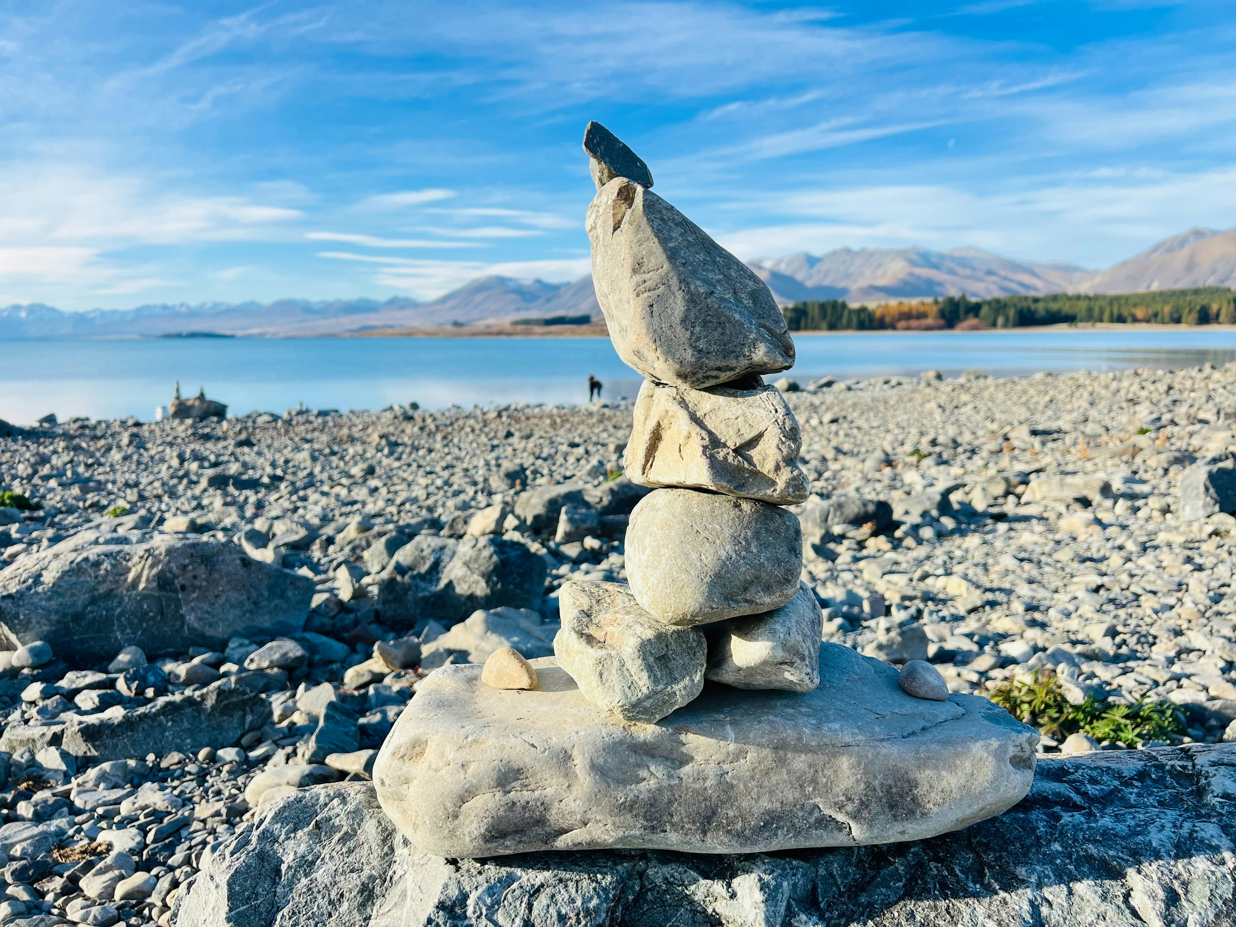 Balanced Pebble Tower by a Quiet Lake