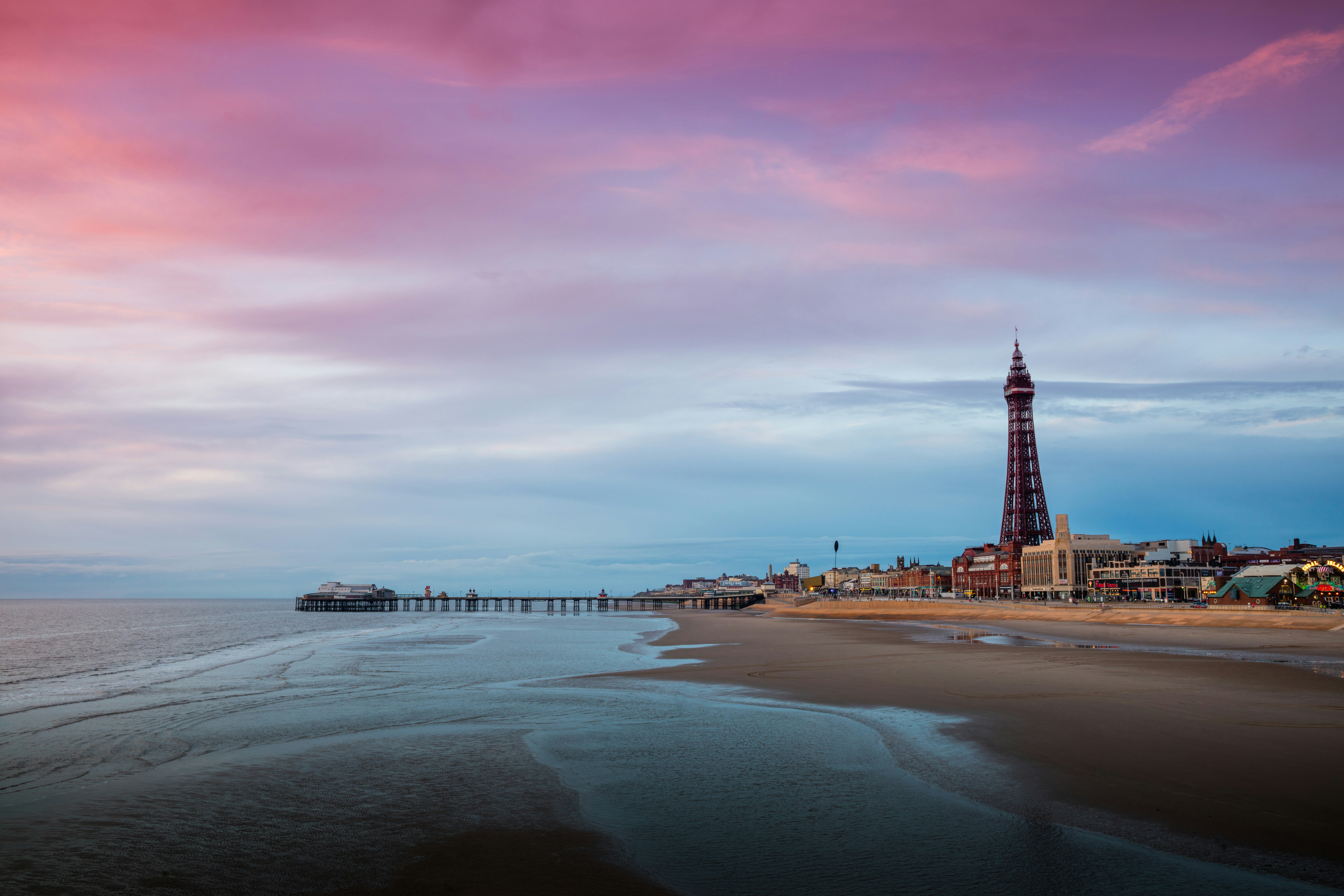 A view of a beach with a lighthouse in the distance photo – Free ...