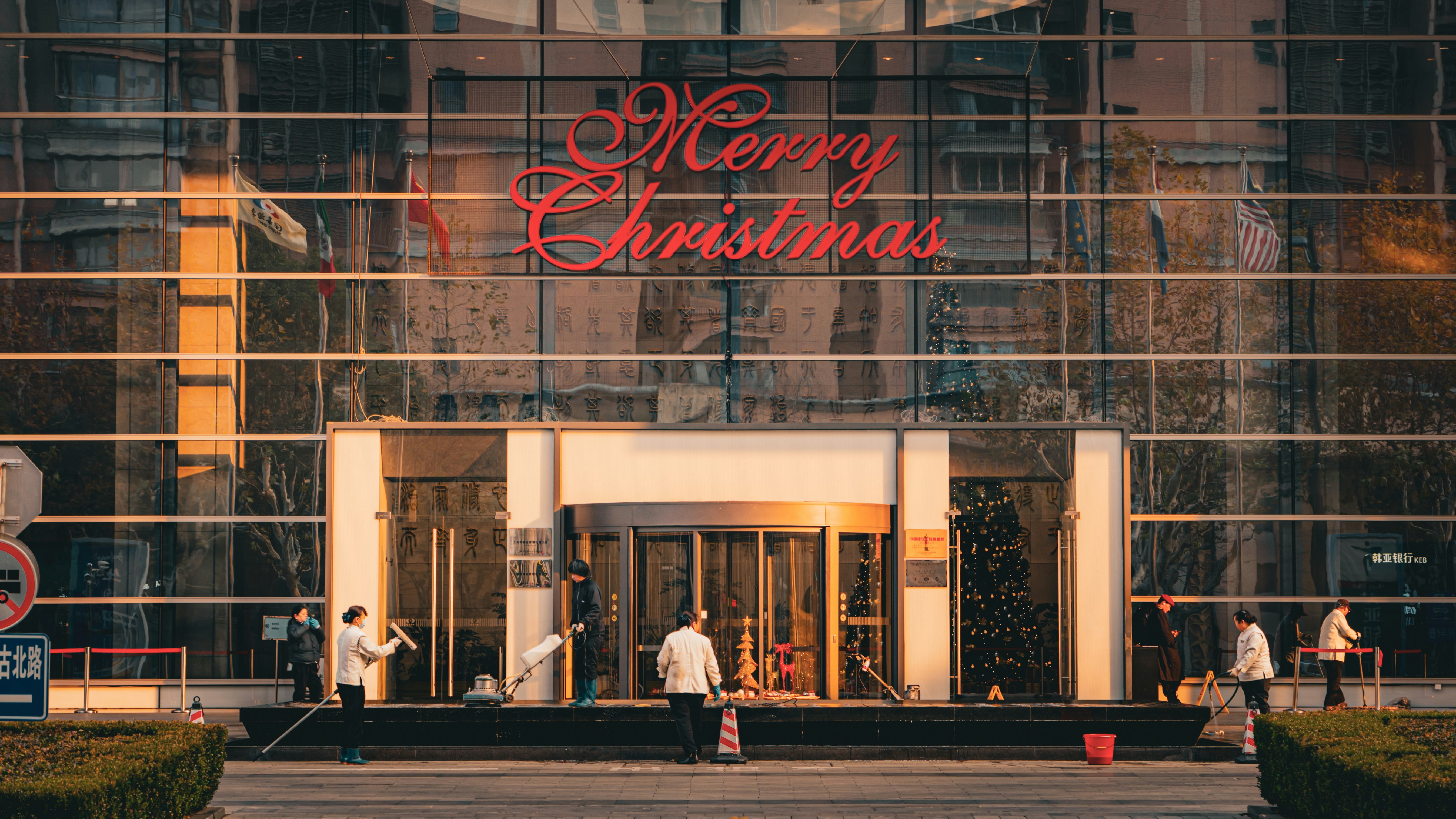 A very tall building with a merry christmas sign on it's side photo ...