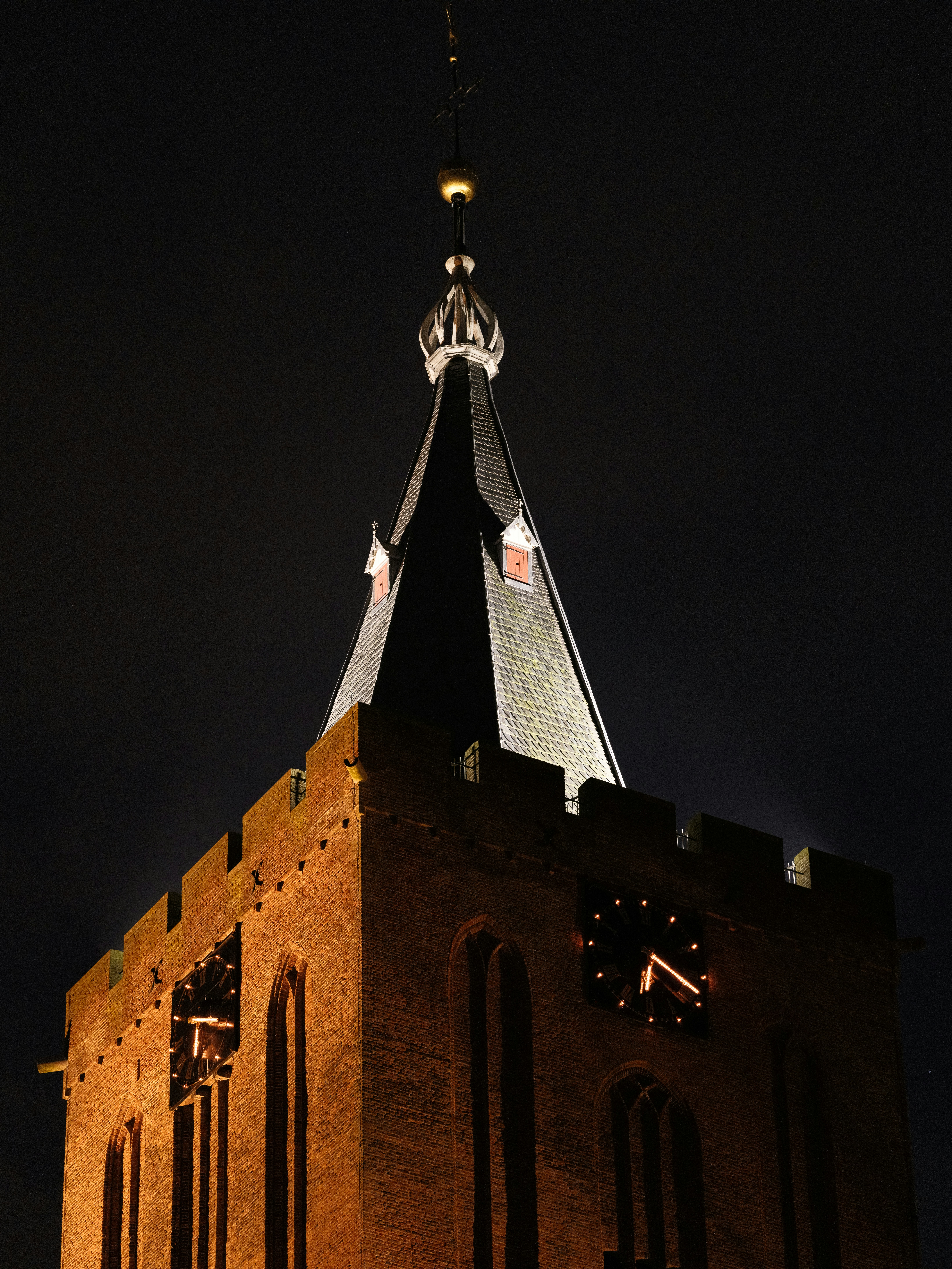 Nocturnal Spire: Illuminated Clock Tower Crowned by Night
