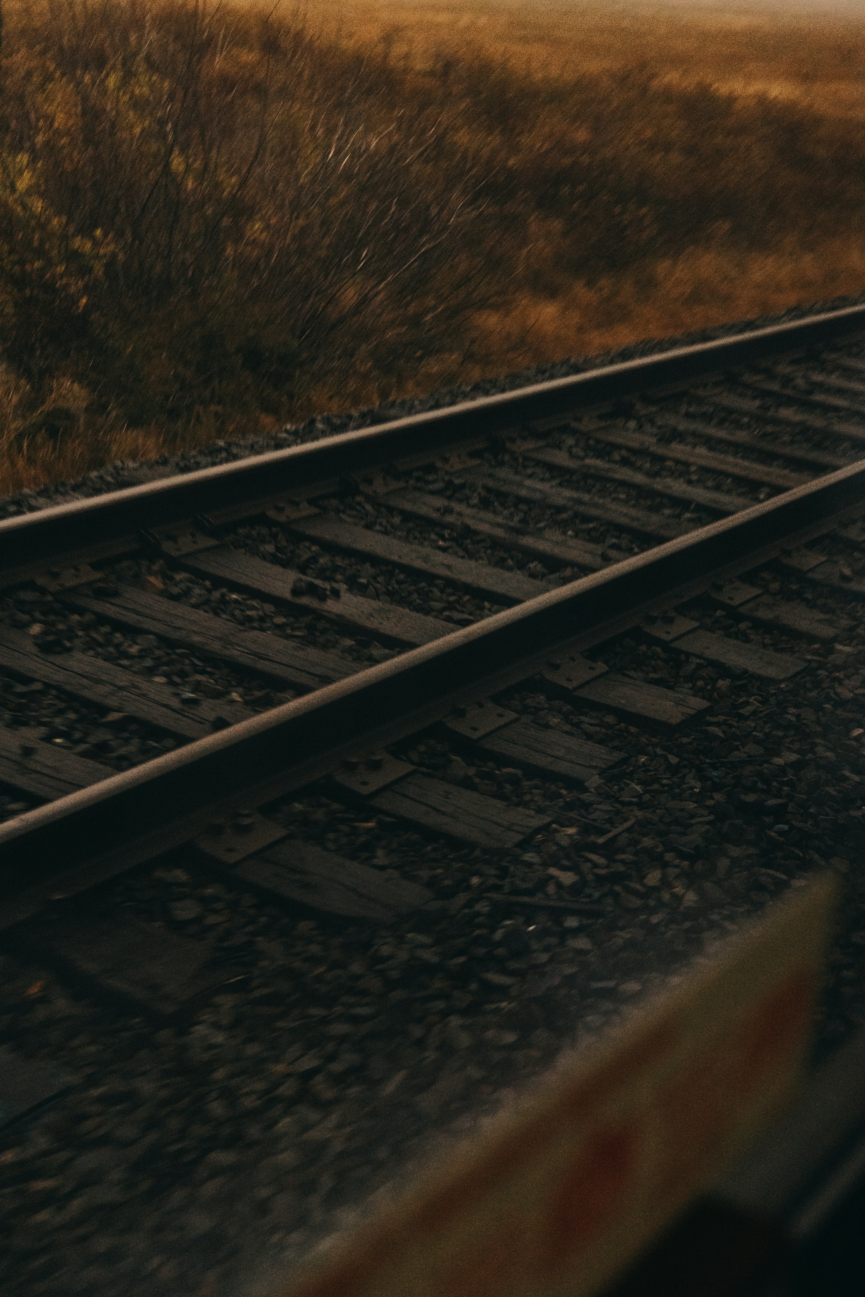 A train track running through a grassy field photo – Free Train ride ...