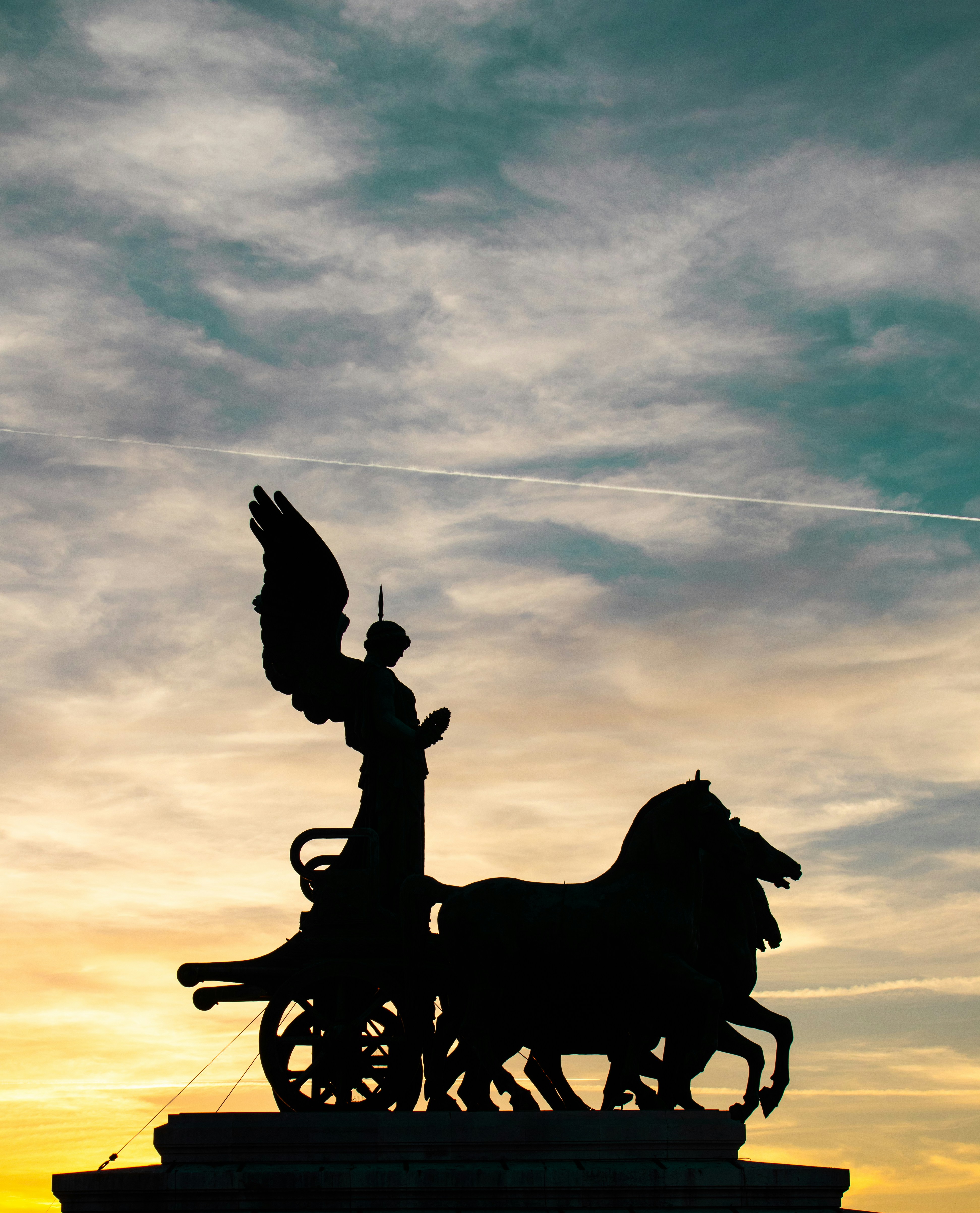 Dusk Winged Charioteer Silhouette Over a Sunset Sky