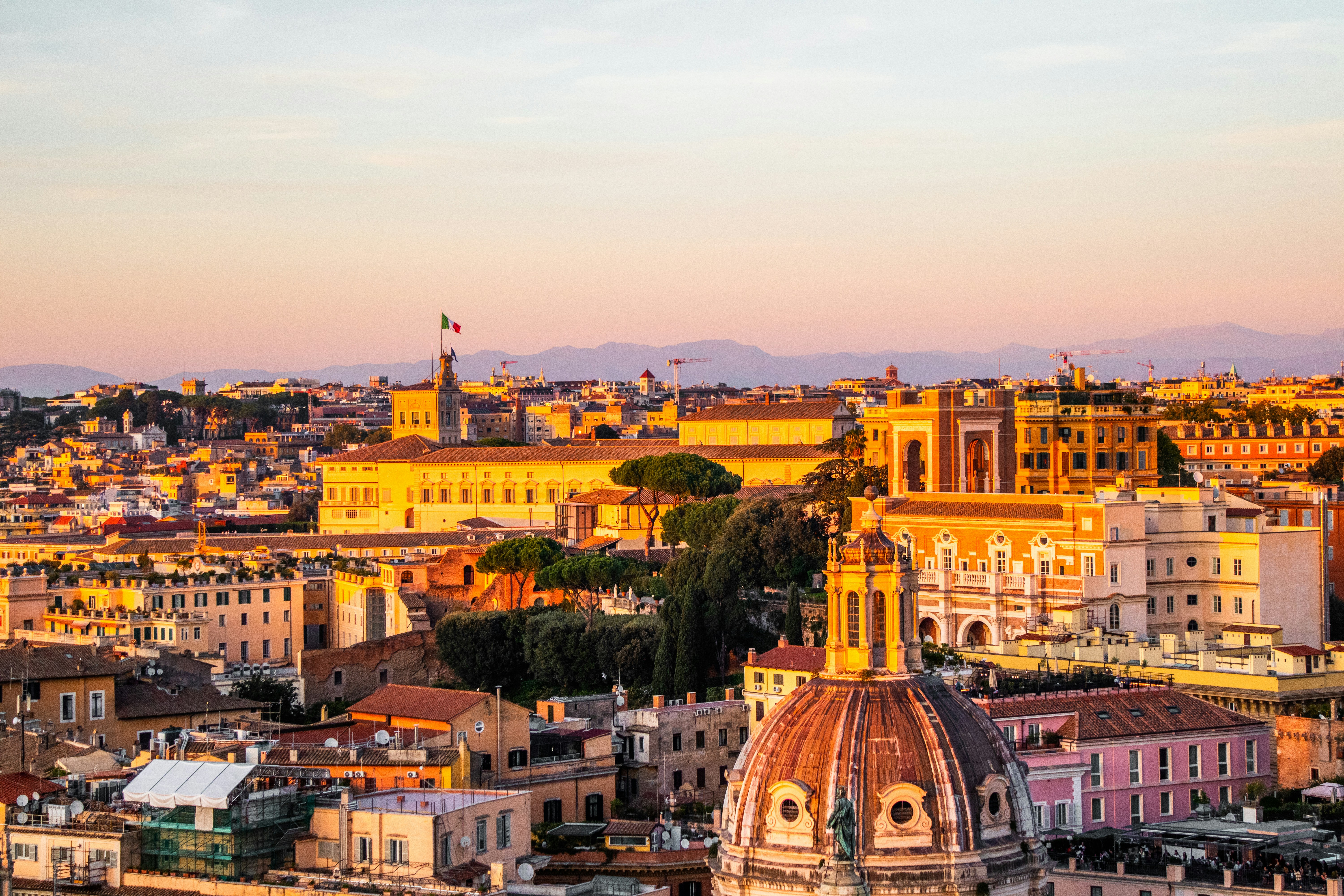 A view of a city with buildings and mountains in the background photo ...