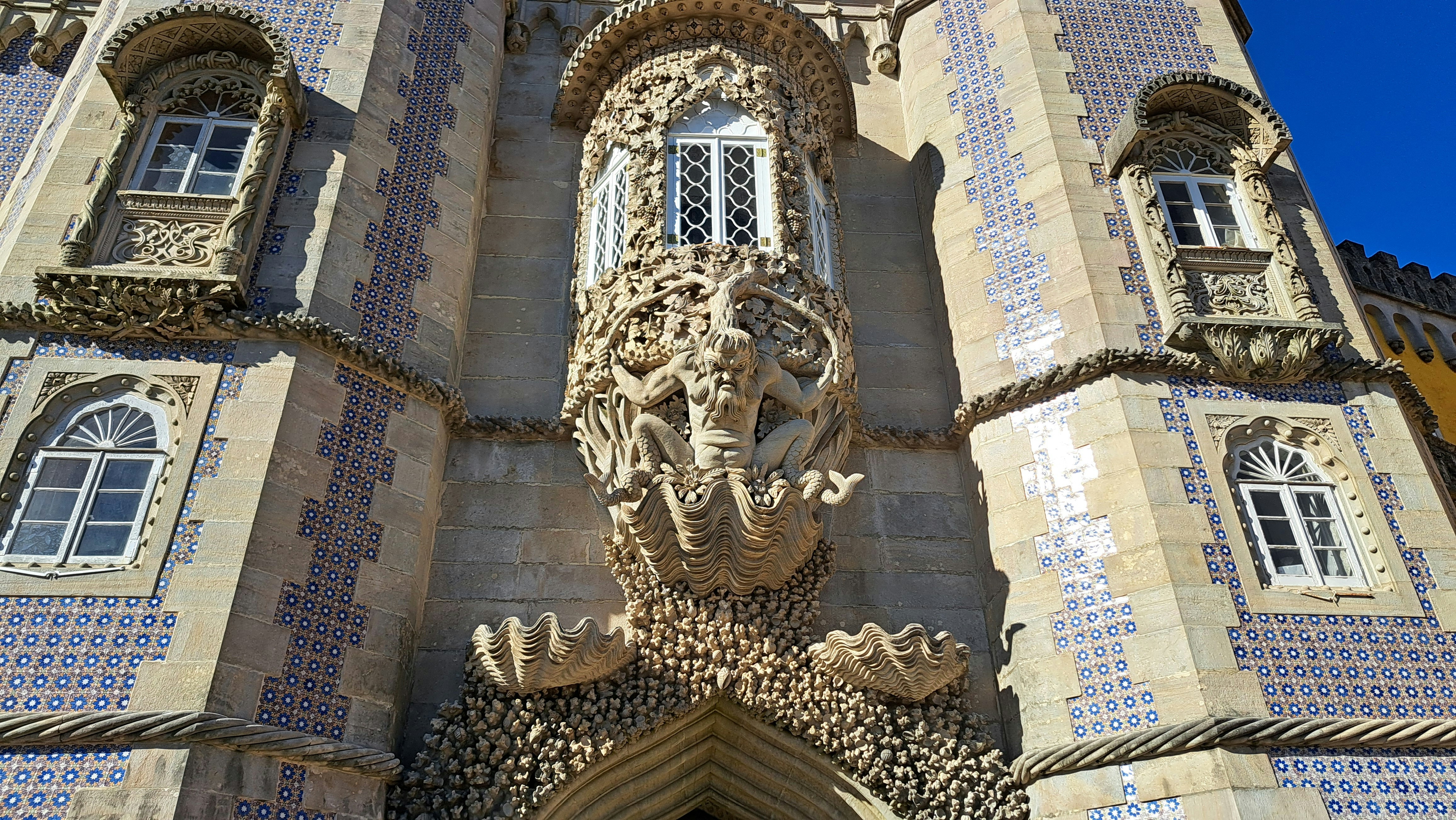 Dragon-Guarded Portal: Sunlit Facade with Ornate Stone Carving