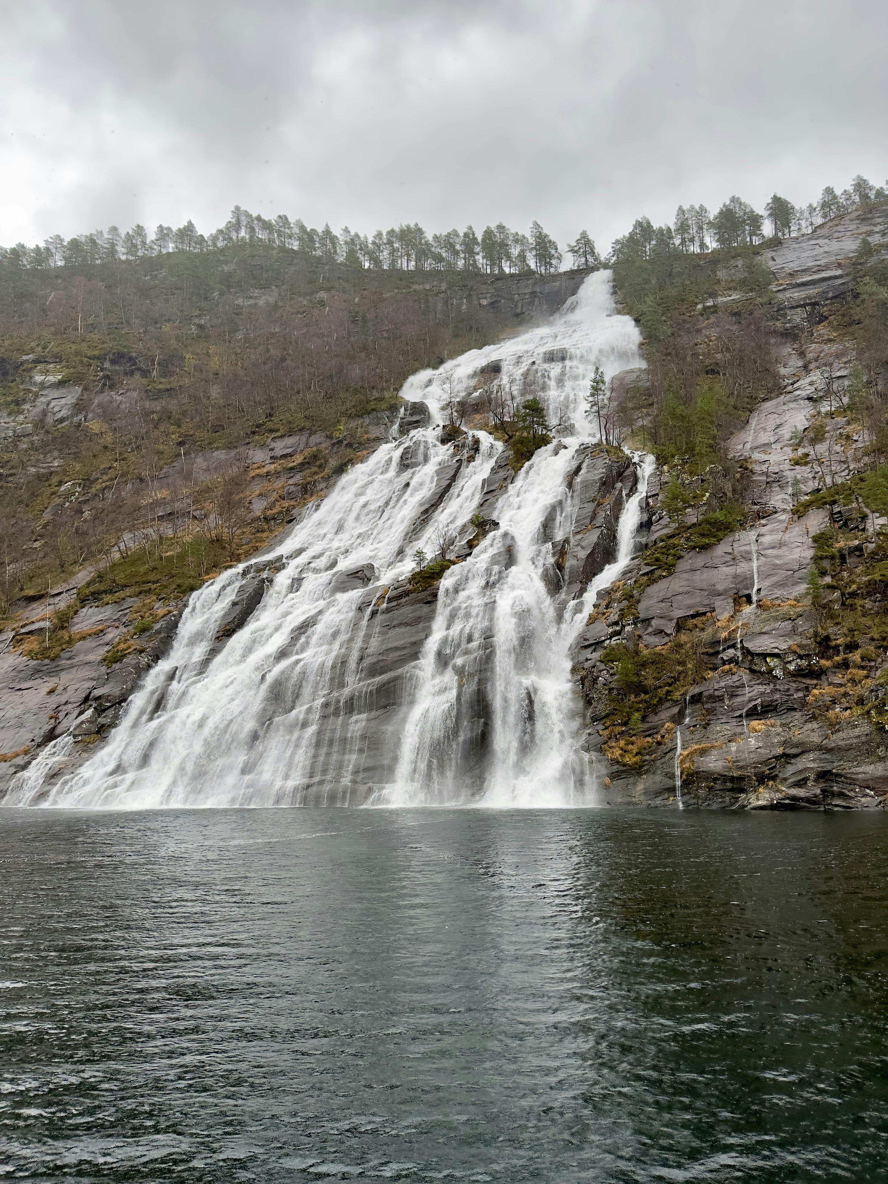 Granite Curtain: A Multi-Threaded Cascade Beneath Cloudy Skies
