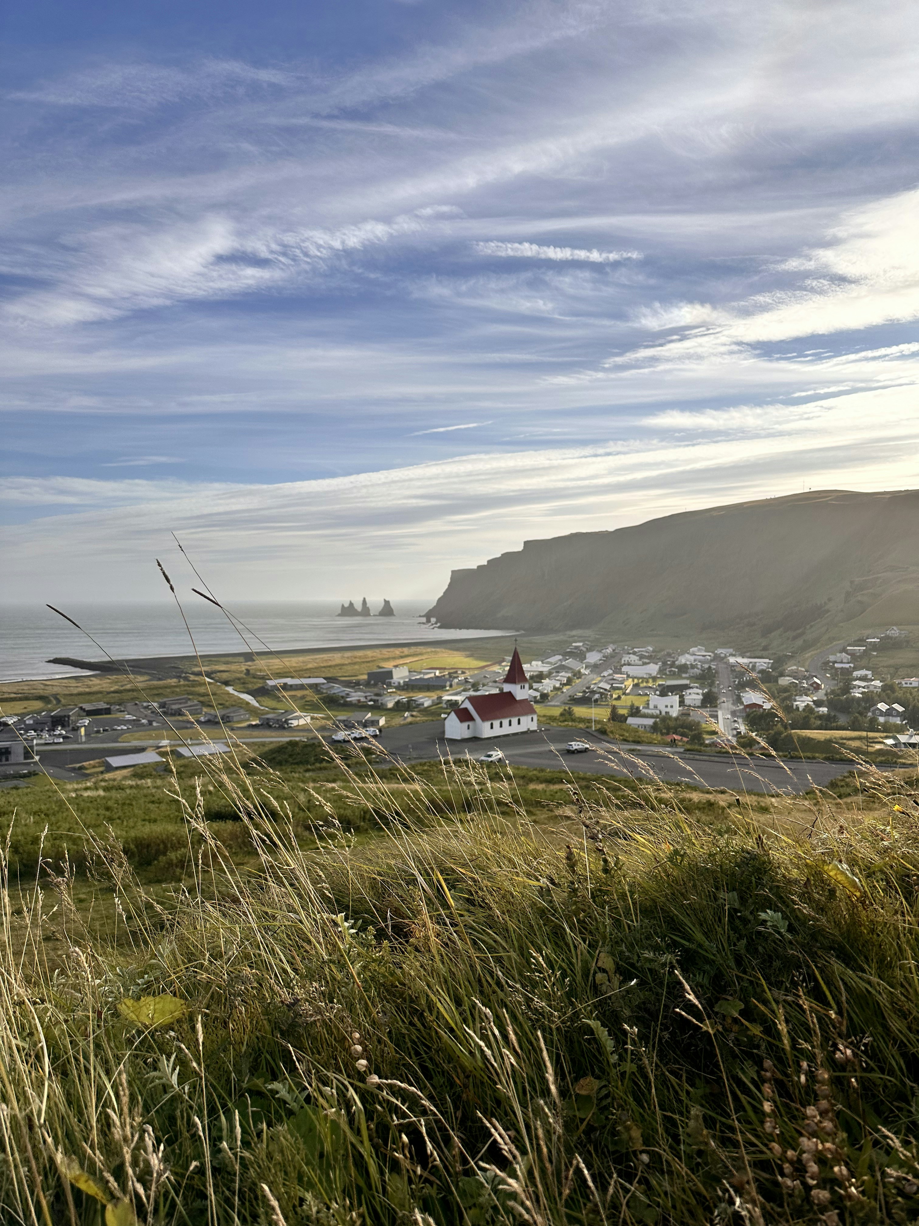 Red-roofed Chapel Guards a Wind-Swept Coastal Village