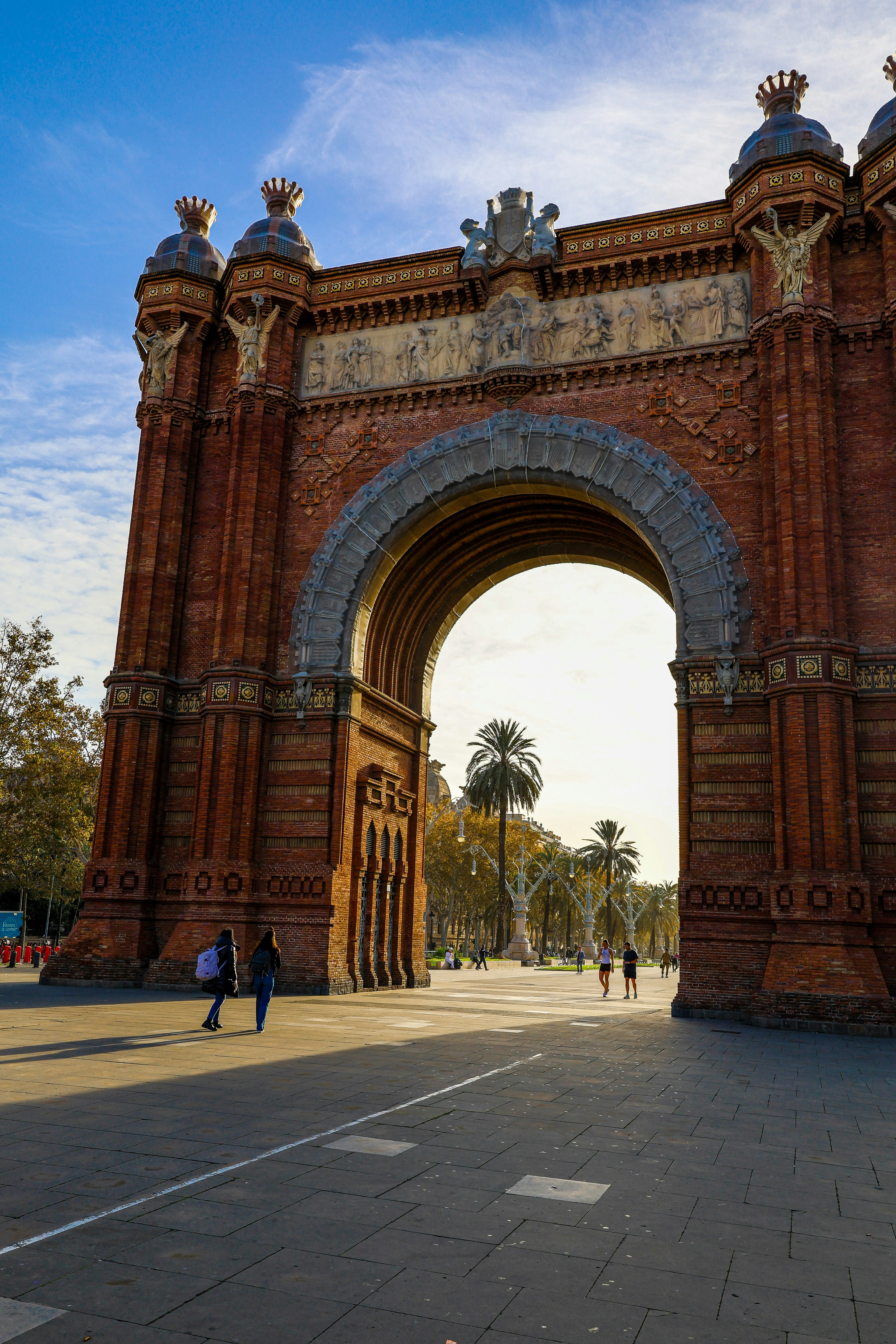 A large brick arch with statues on top of it photo – Free Wallpaper ...