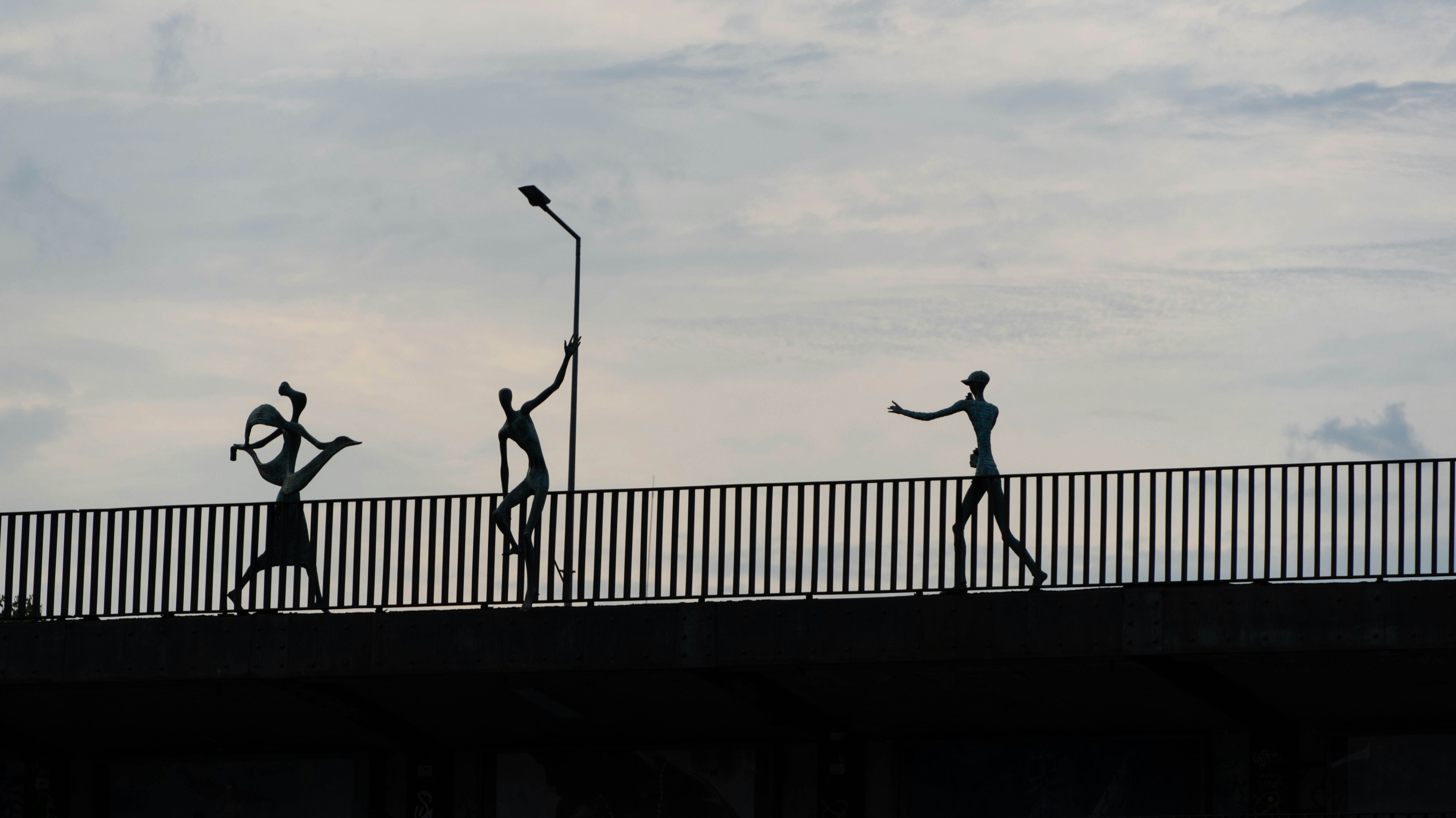Mid-Bridge Ballet: silhouettes in motion along the urban span