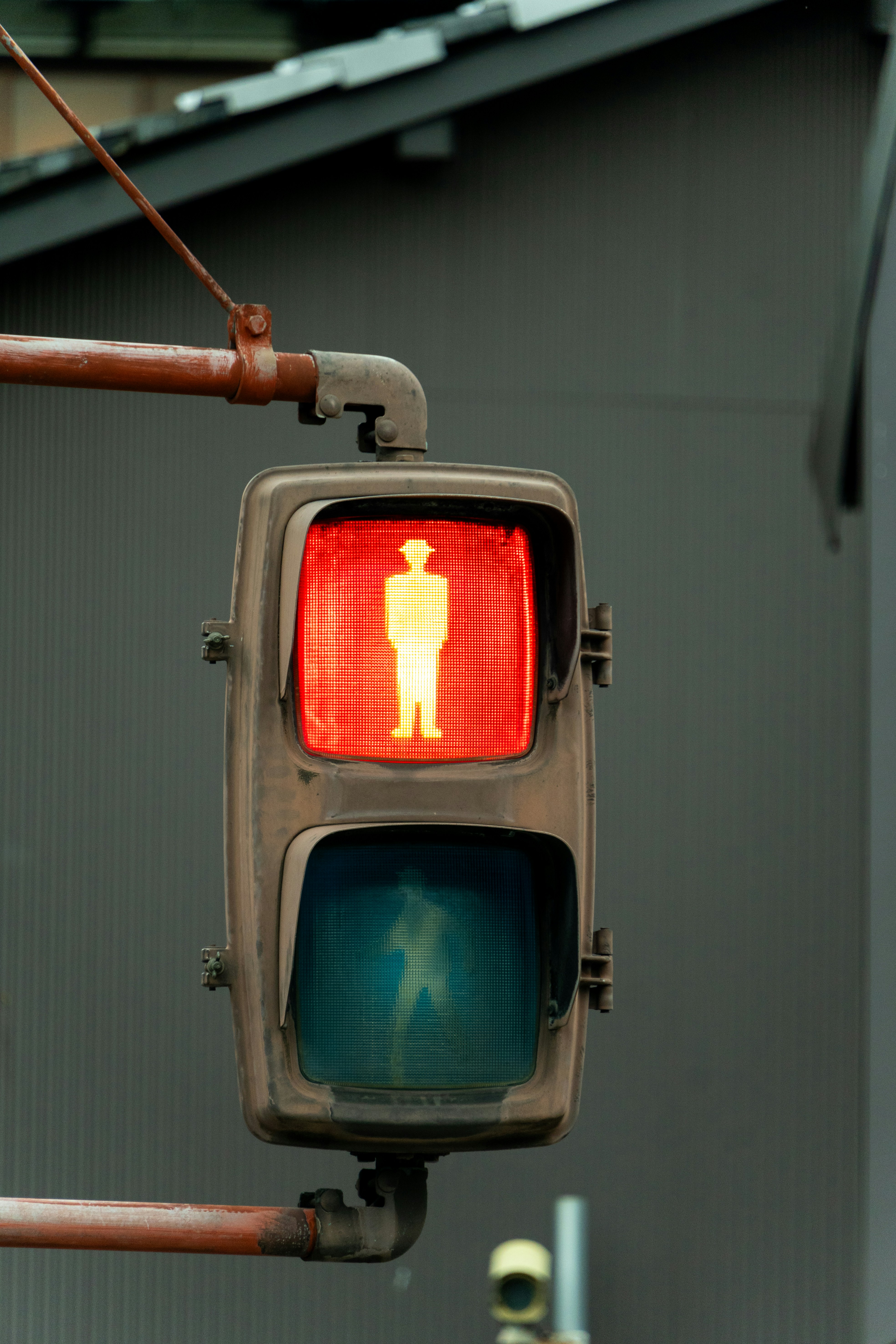 Red Sentinel Over Rusted Pipes