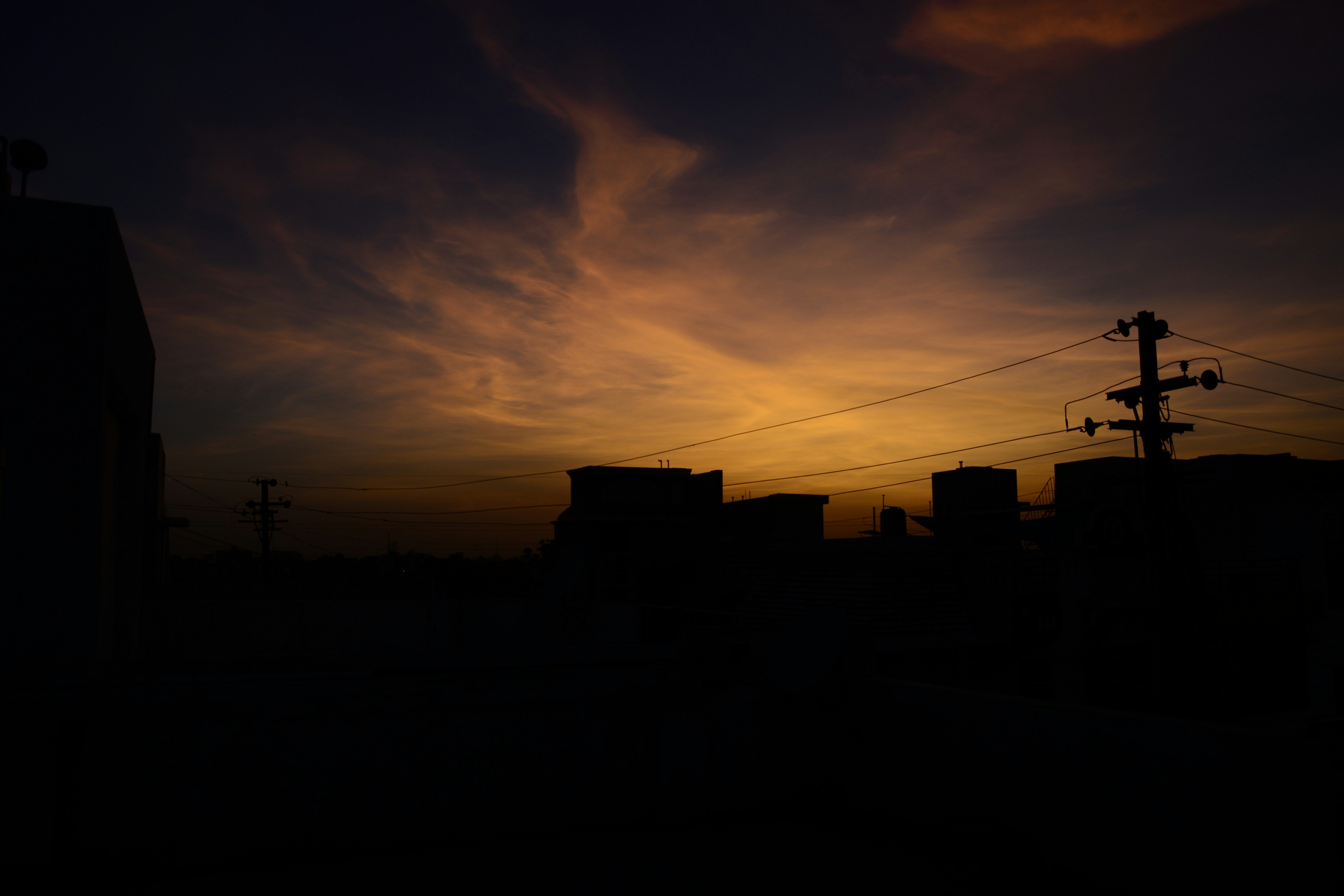 Just after the Sunset. | The sun is setting over a city with tall buildings