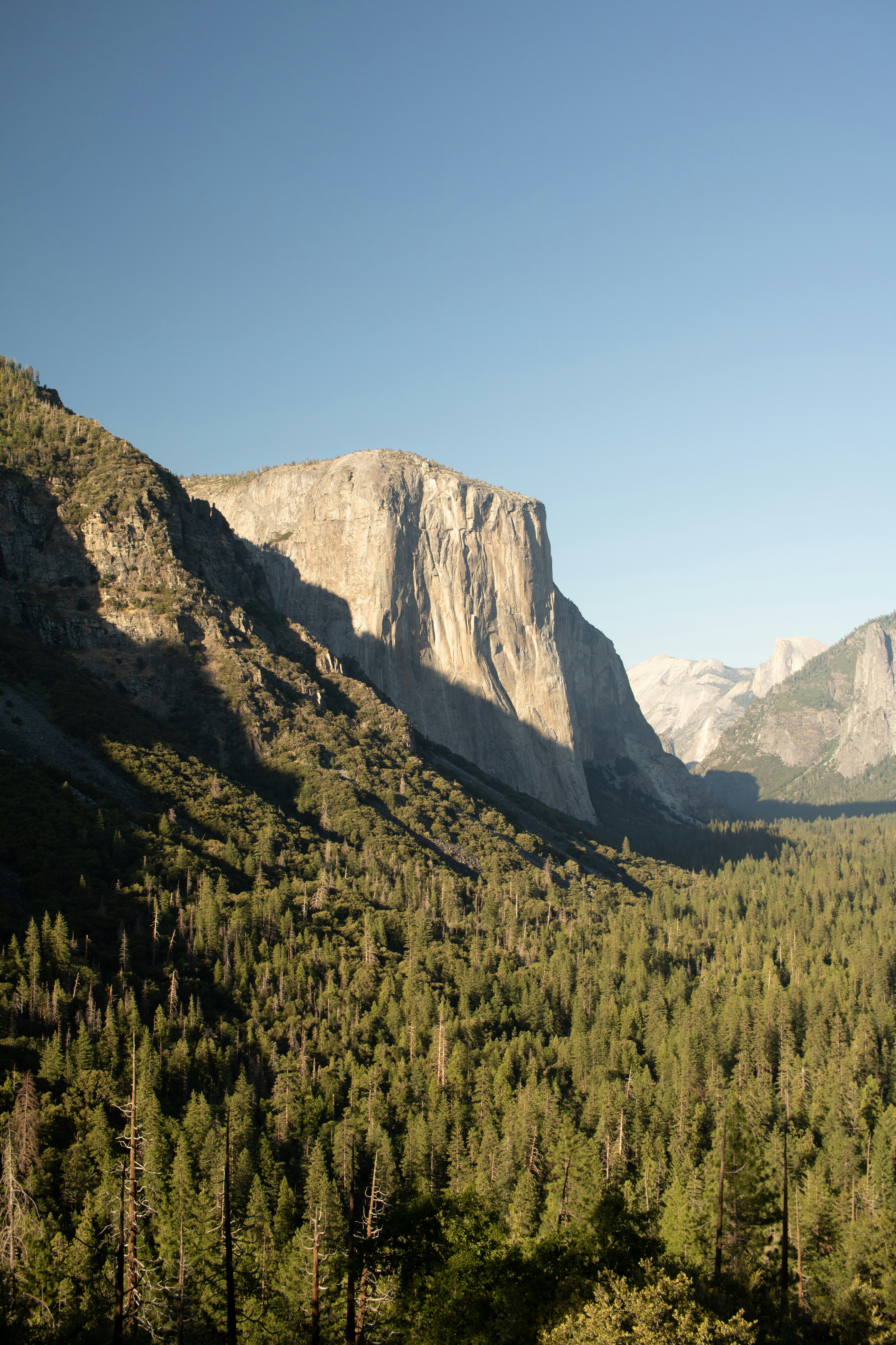 A view of a valley with a mountain in the background photo – Free Tunnel view Image on Unsplash