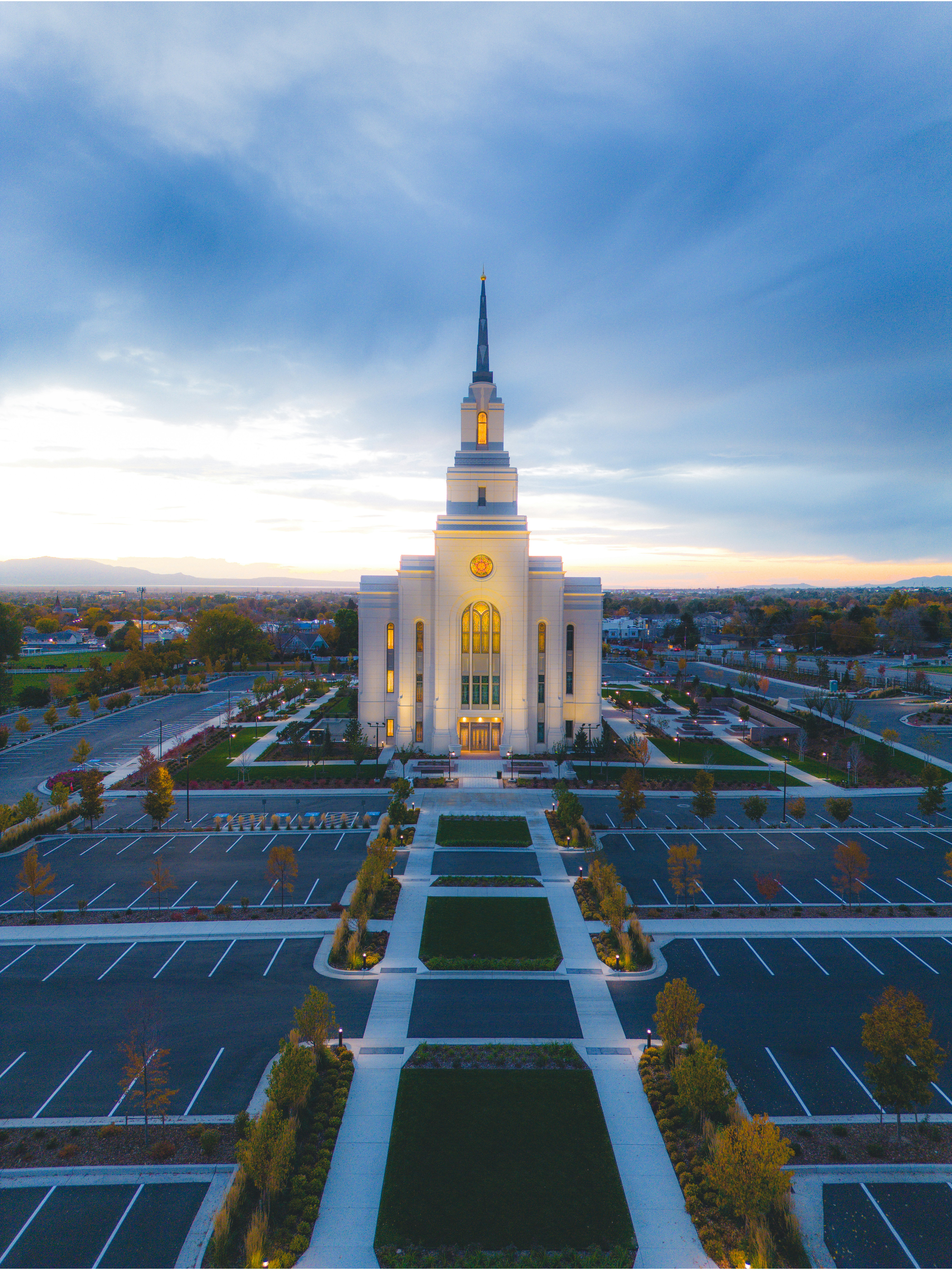 An aerial view of a church in the middle of a parking lot