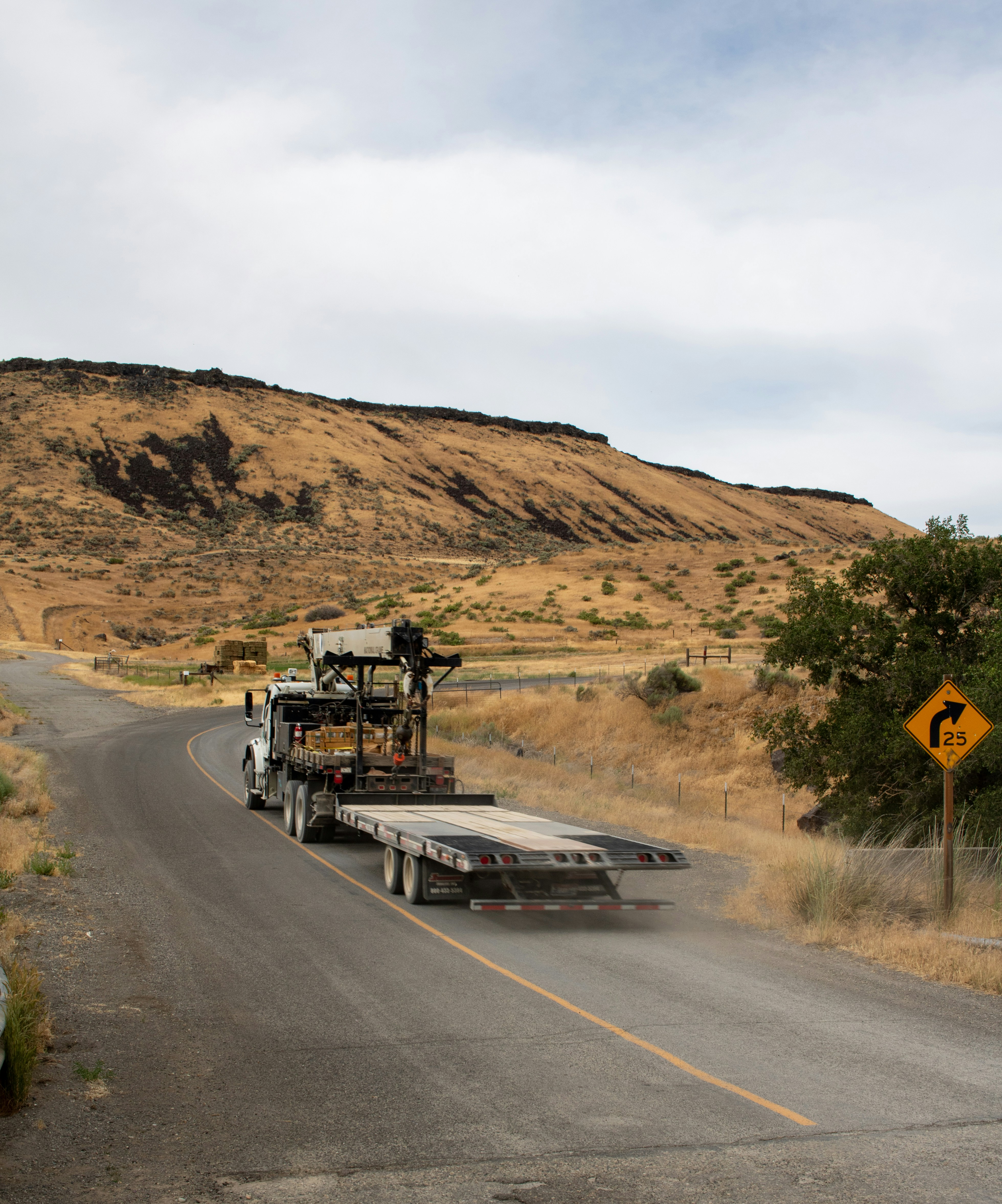 A semi truck drives up a turning road in Idaho