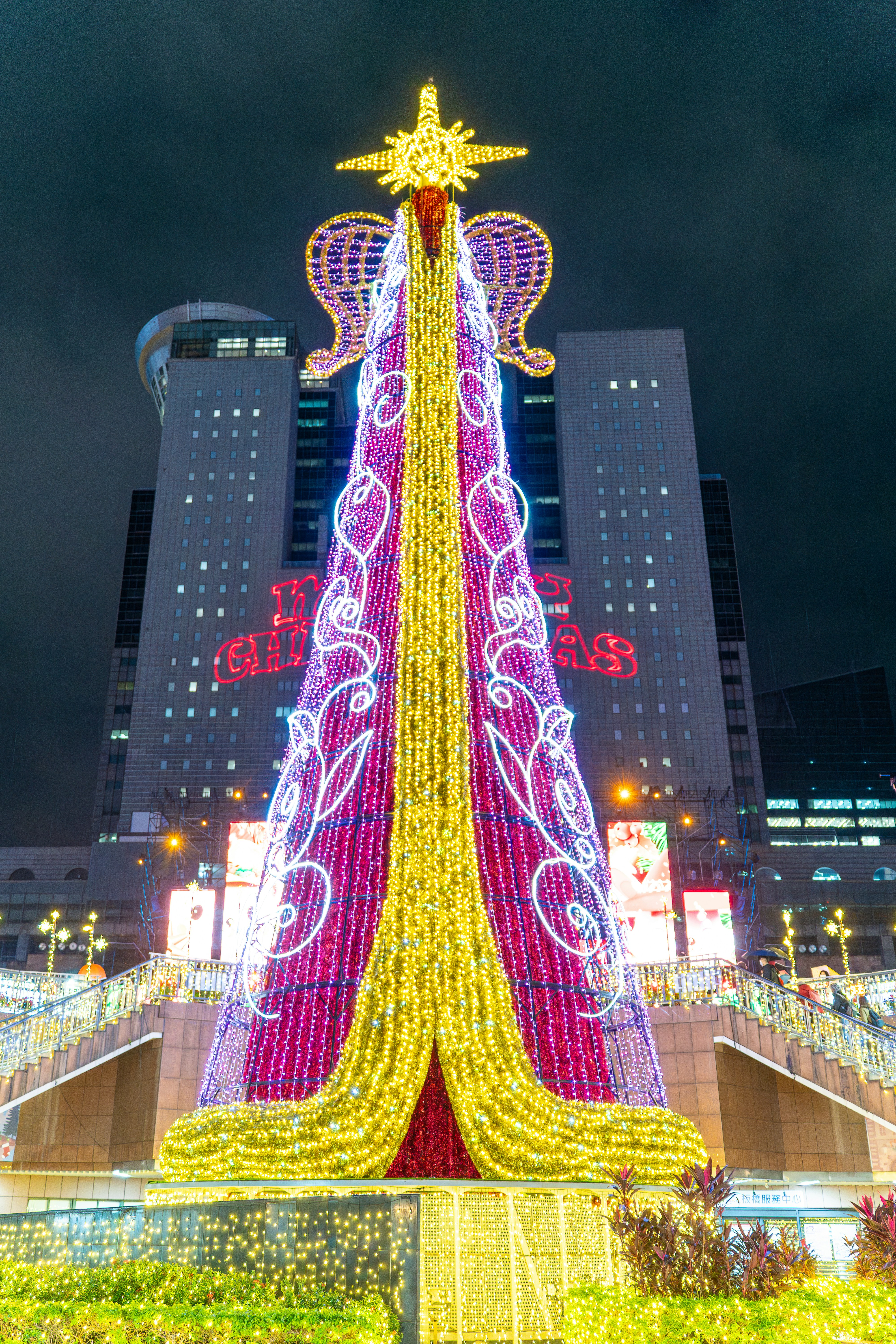 A large lighted christmas tree in front of a building photo – Free ...