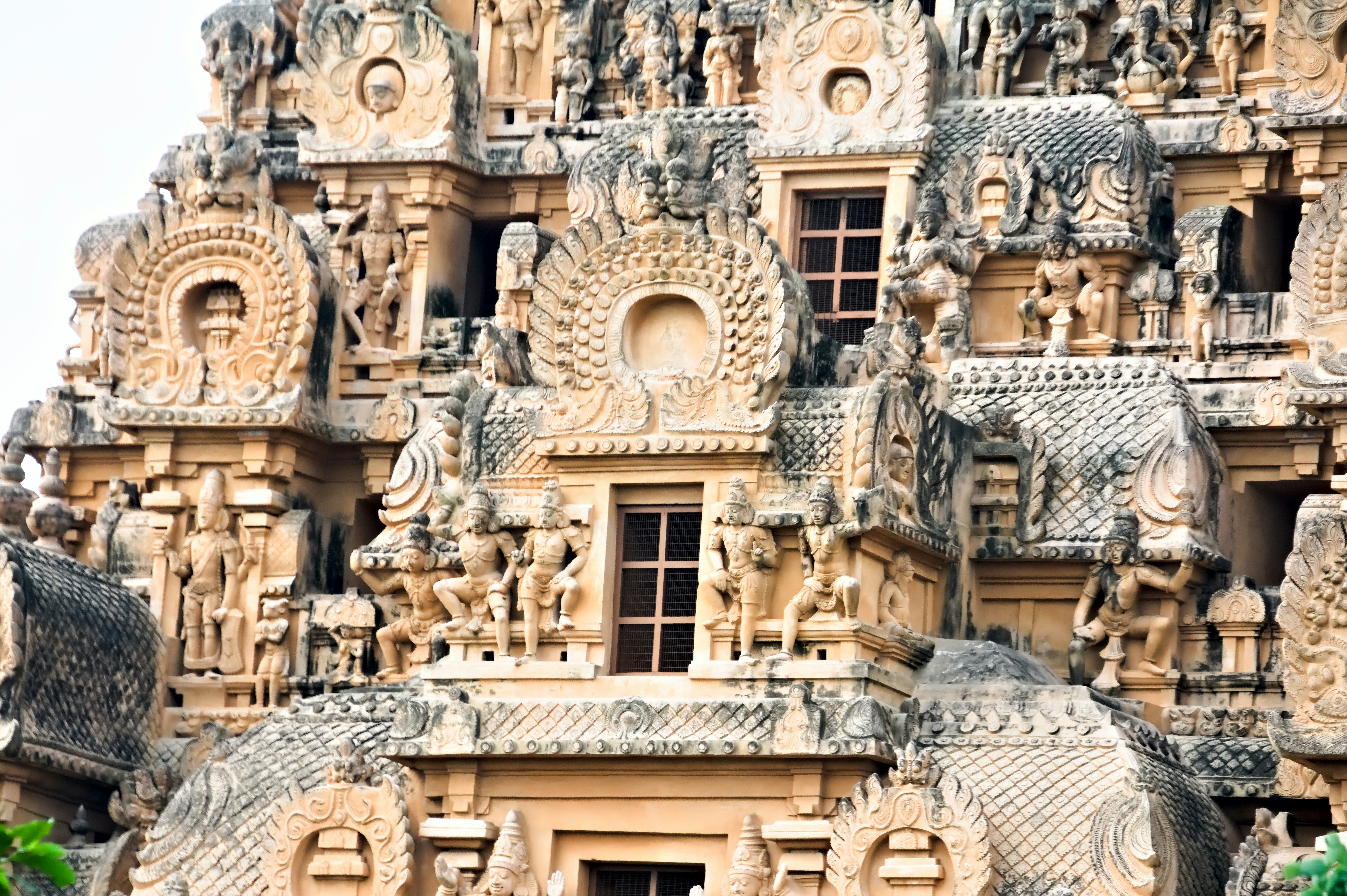 A very tall building with statues on it's sides photo – Free Art Image ...