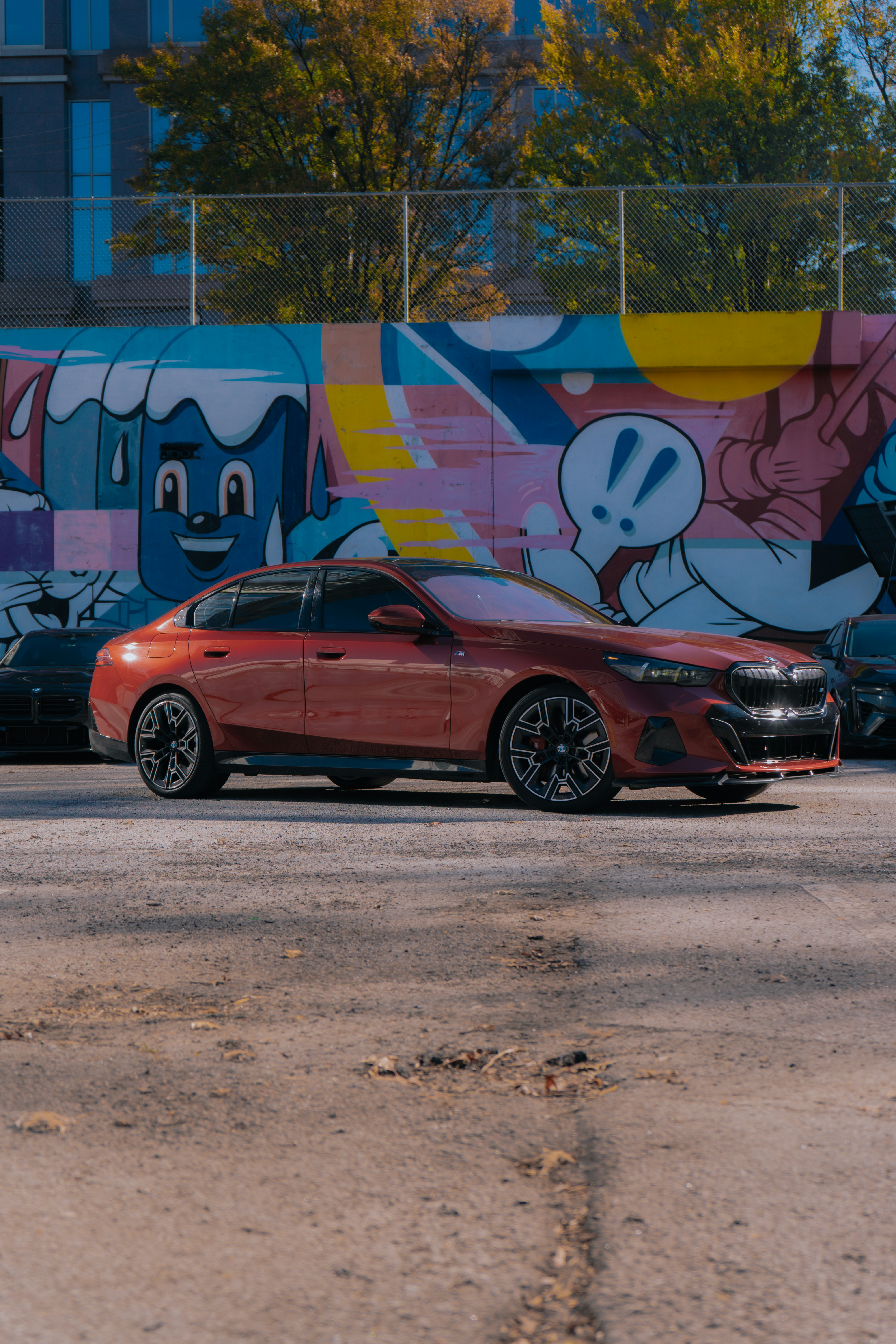 A red car parked in front of a colorful wall photo – Free Car Image on ...