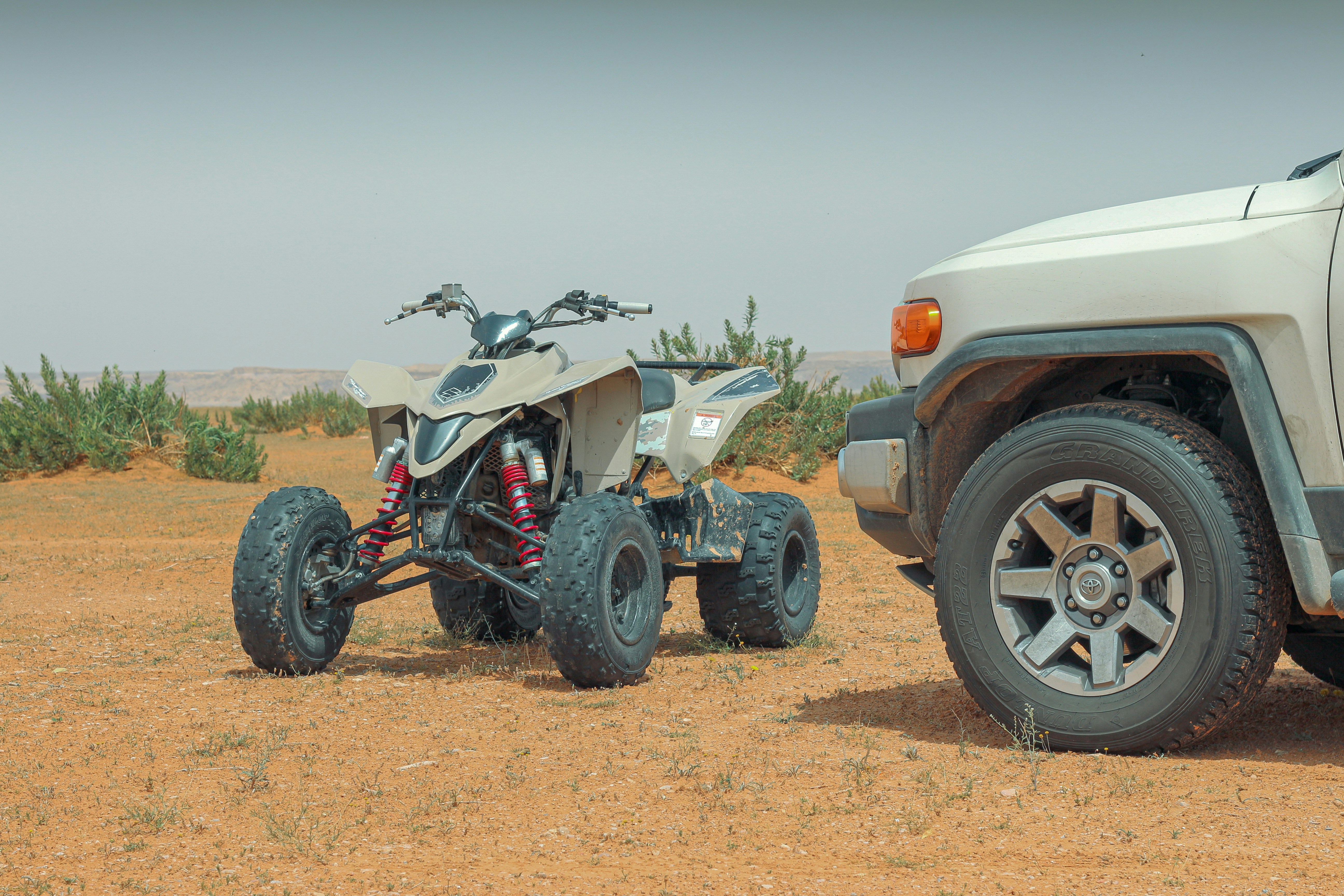 A white four wheeler parked next to a white truck photo – Free Riyadh ...