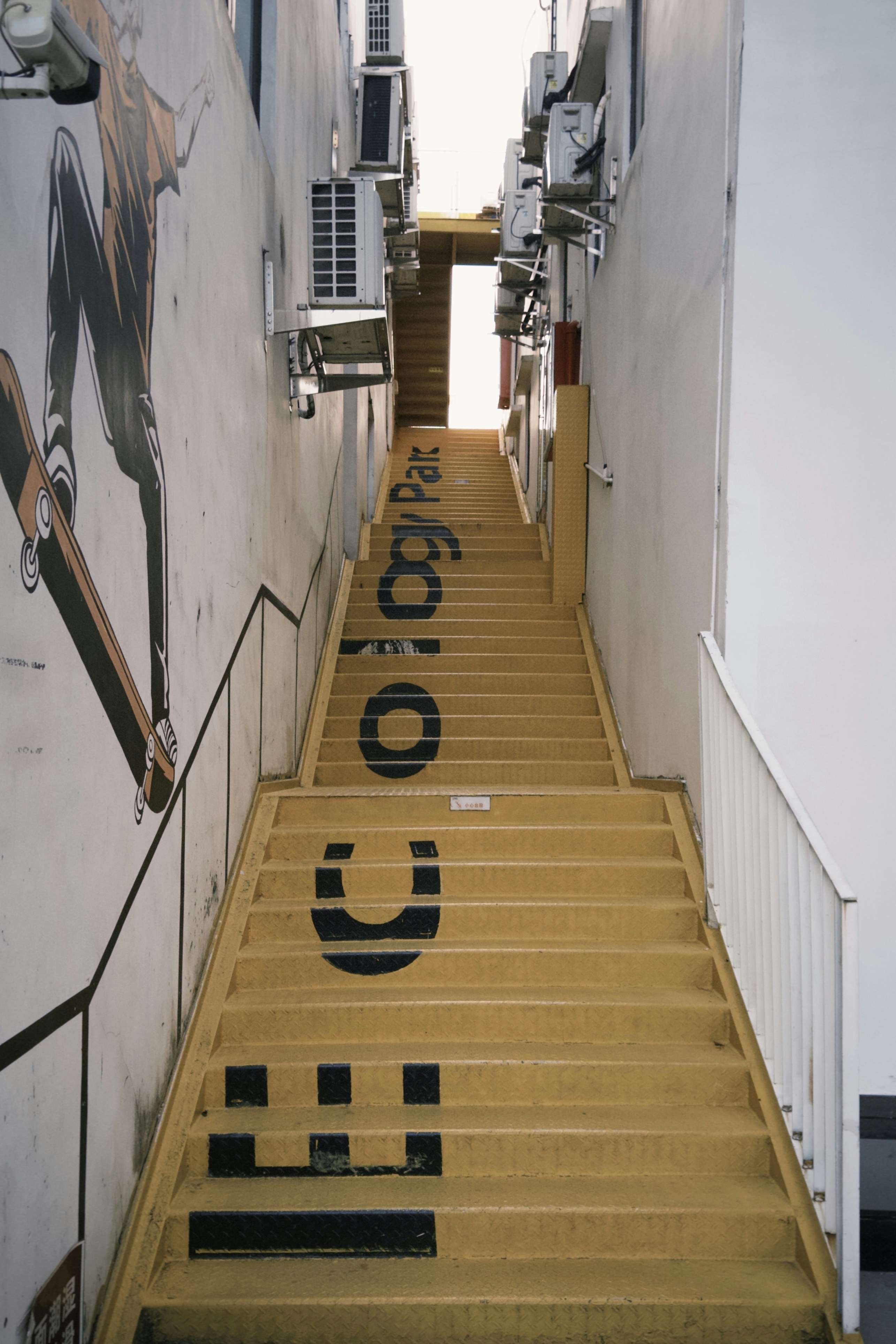 A set of yellow stairs leading up to a building photo – Free City Image ...