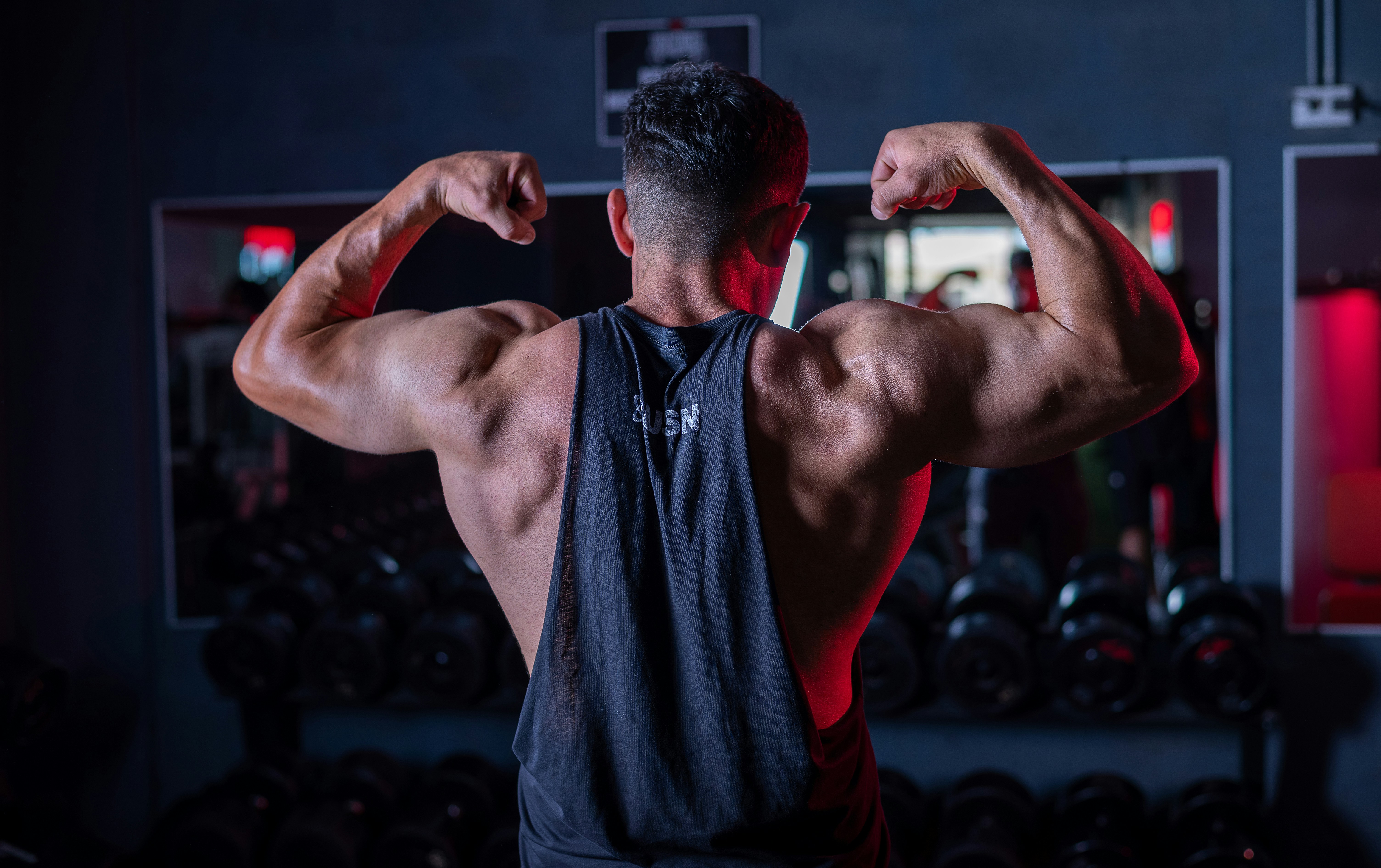 A man flexing his muscles in a gym photo – Free Adult Image on Unsplash