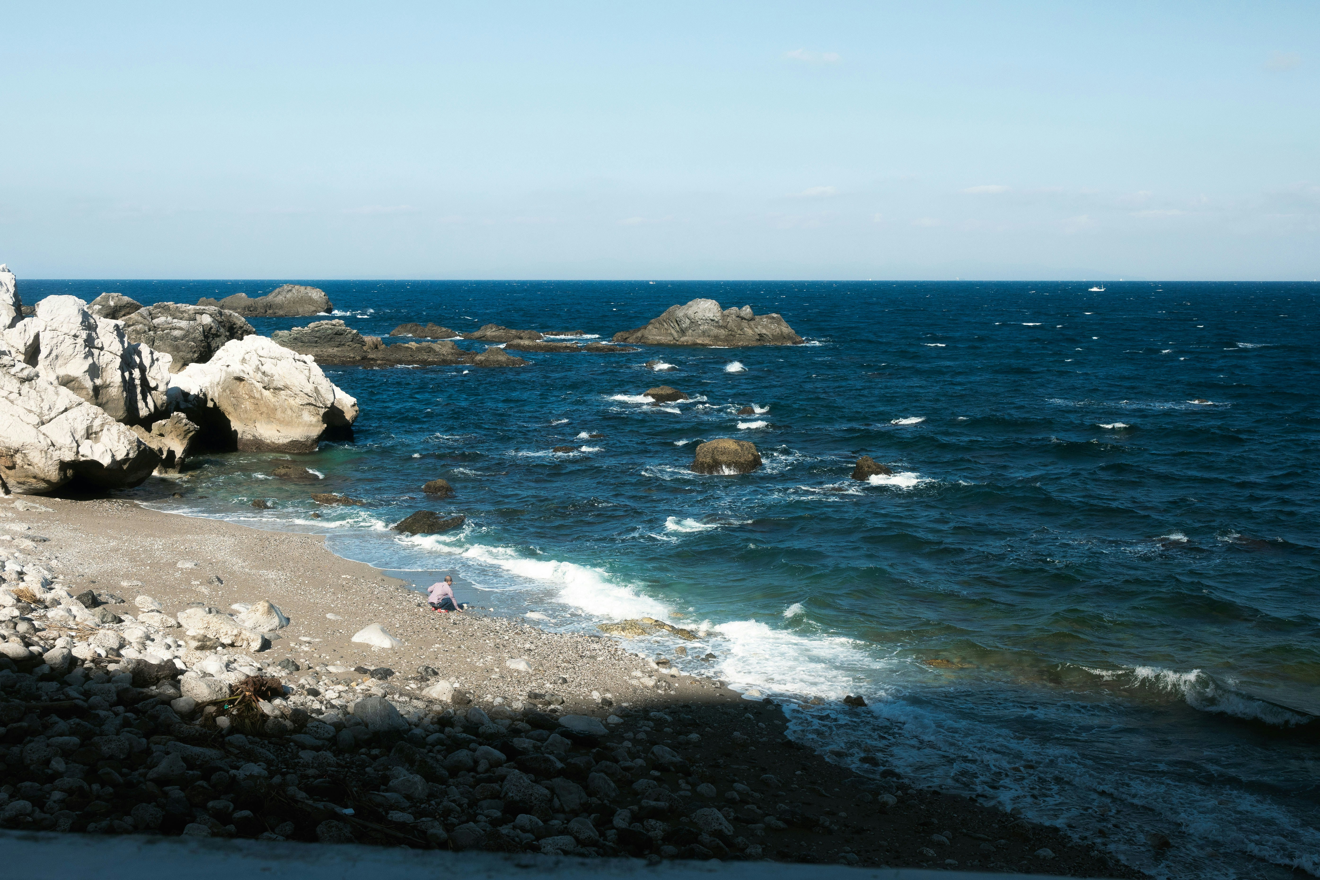 A view of a beach with rocks and water photo – Free Wallpaper Image on ...