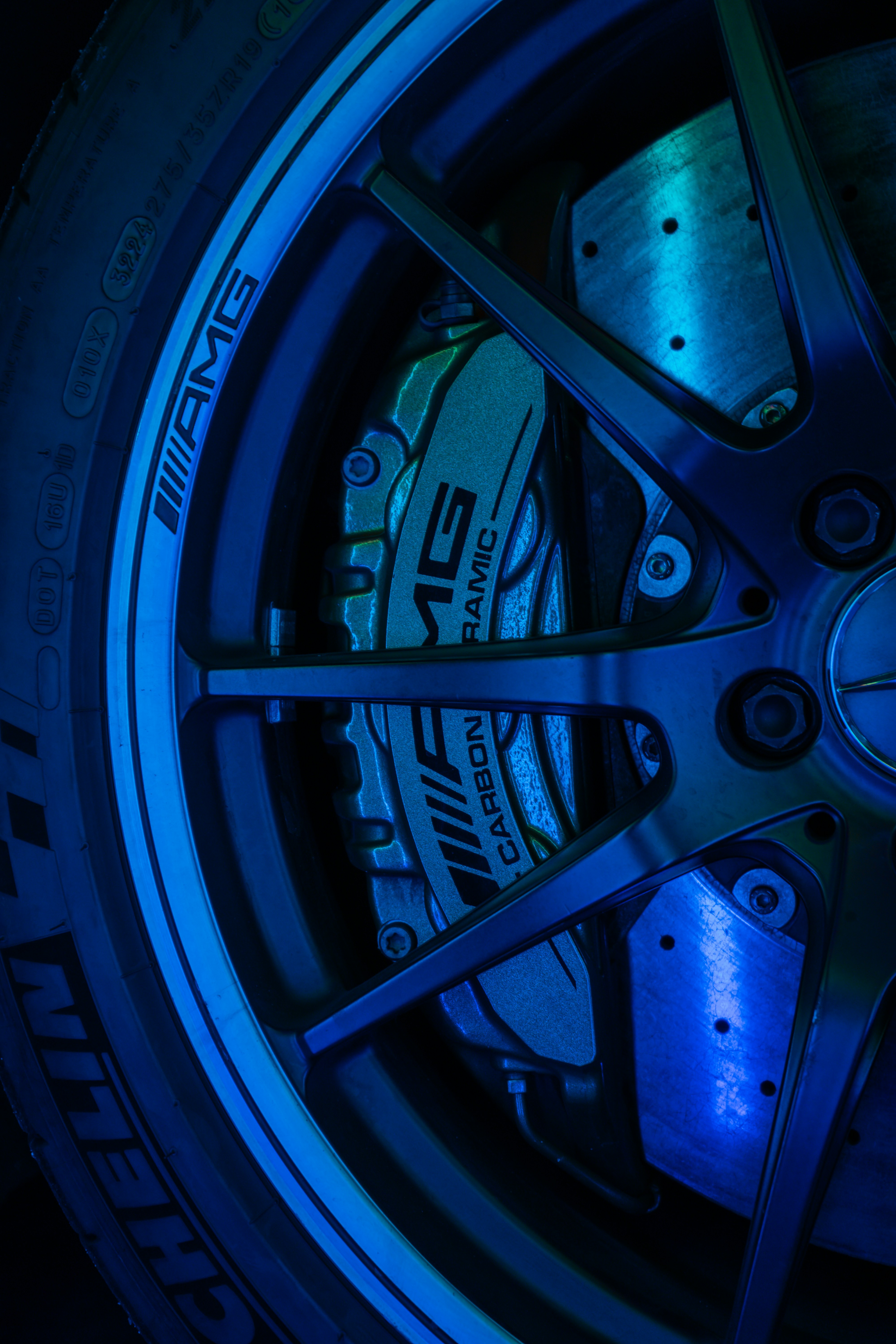 Blue Neon Detail: AMG Carbon Ceramic Brake Visible Through Spoked Mercedes Wheel