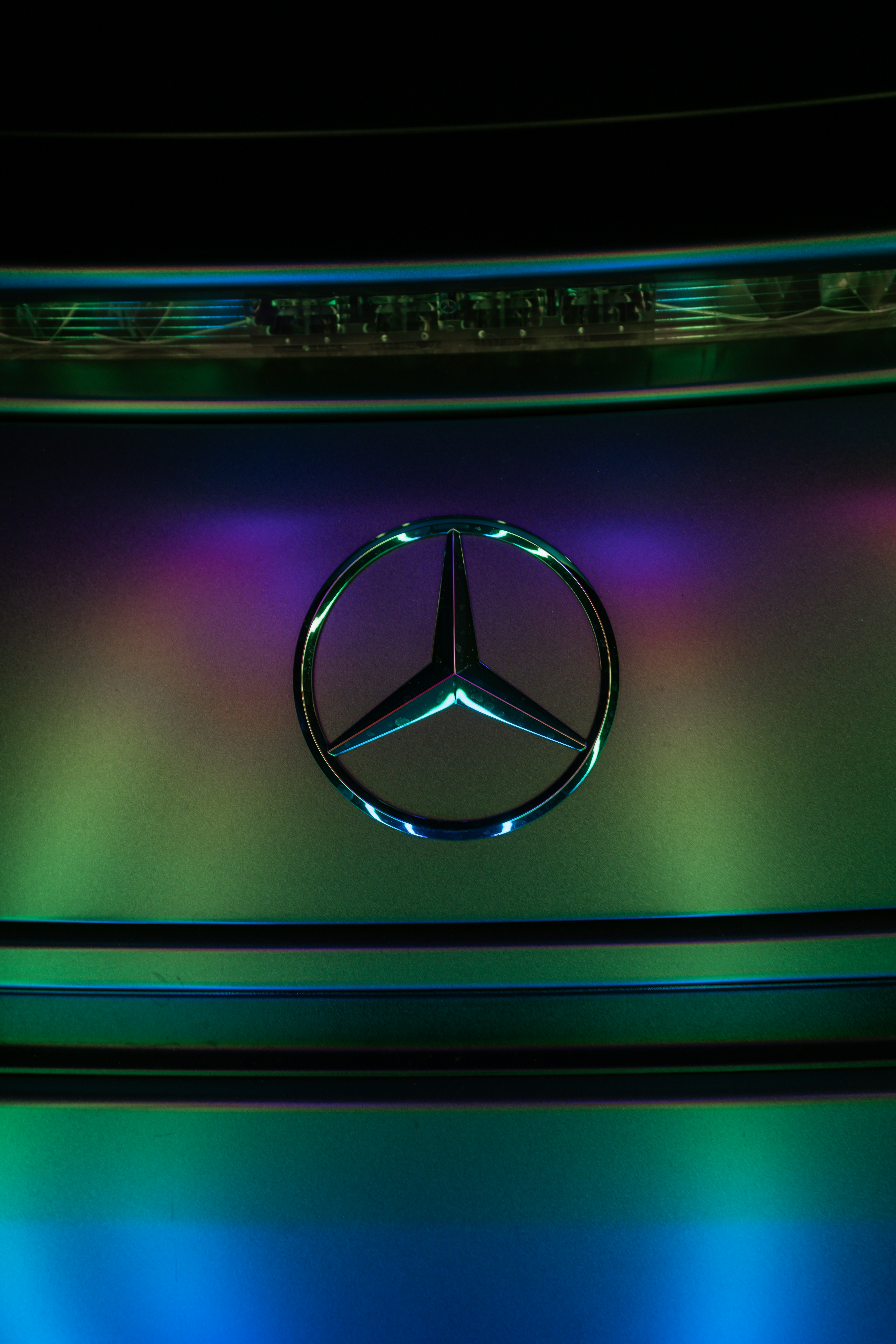 Chromatic Crest: The Mercedes-Benz Star Bathed in Neon Iridescence