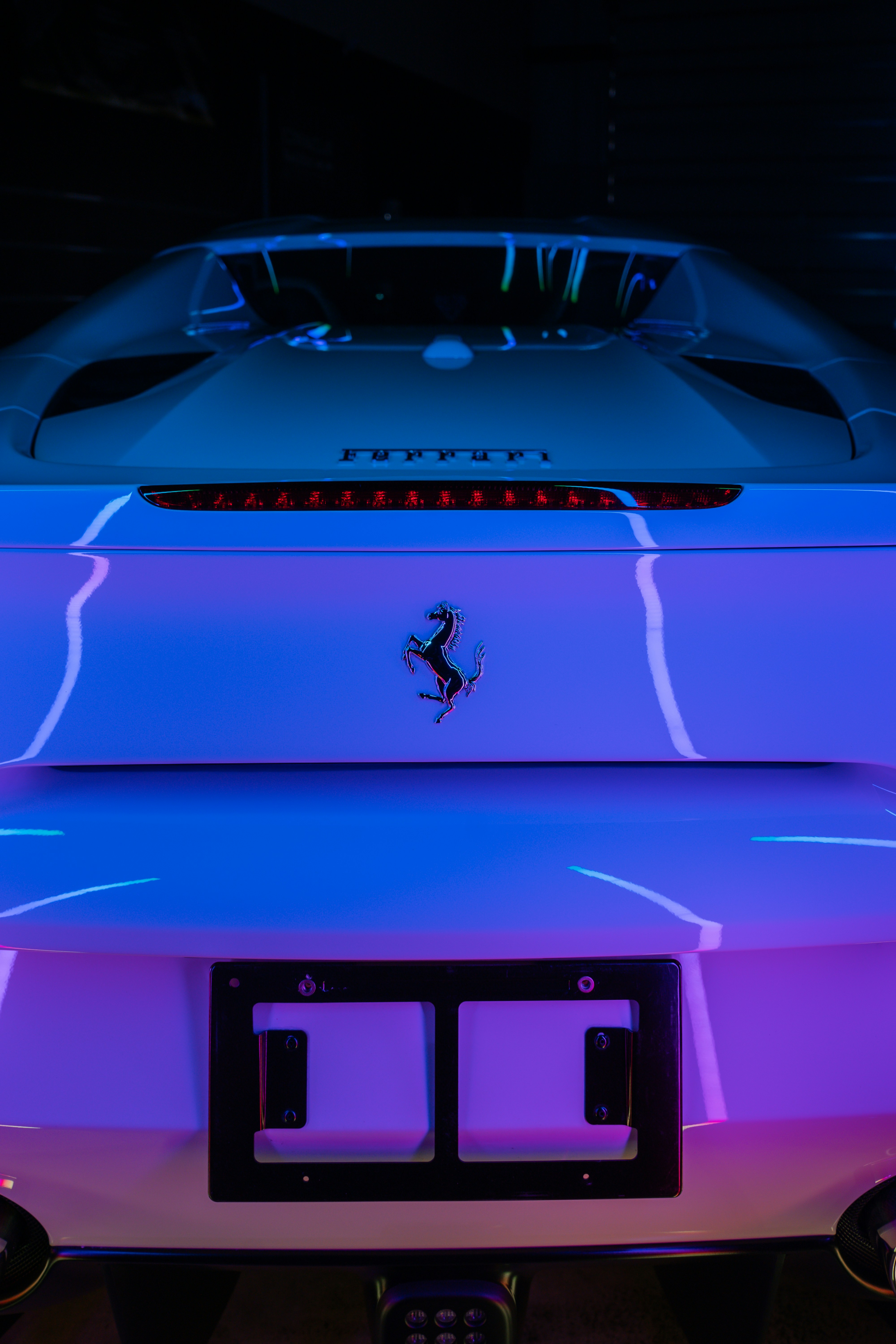 The rear end of a sports car in a dark room photo – Free Atlanta Image ...