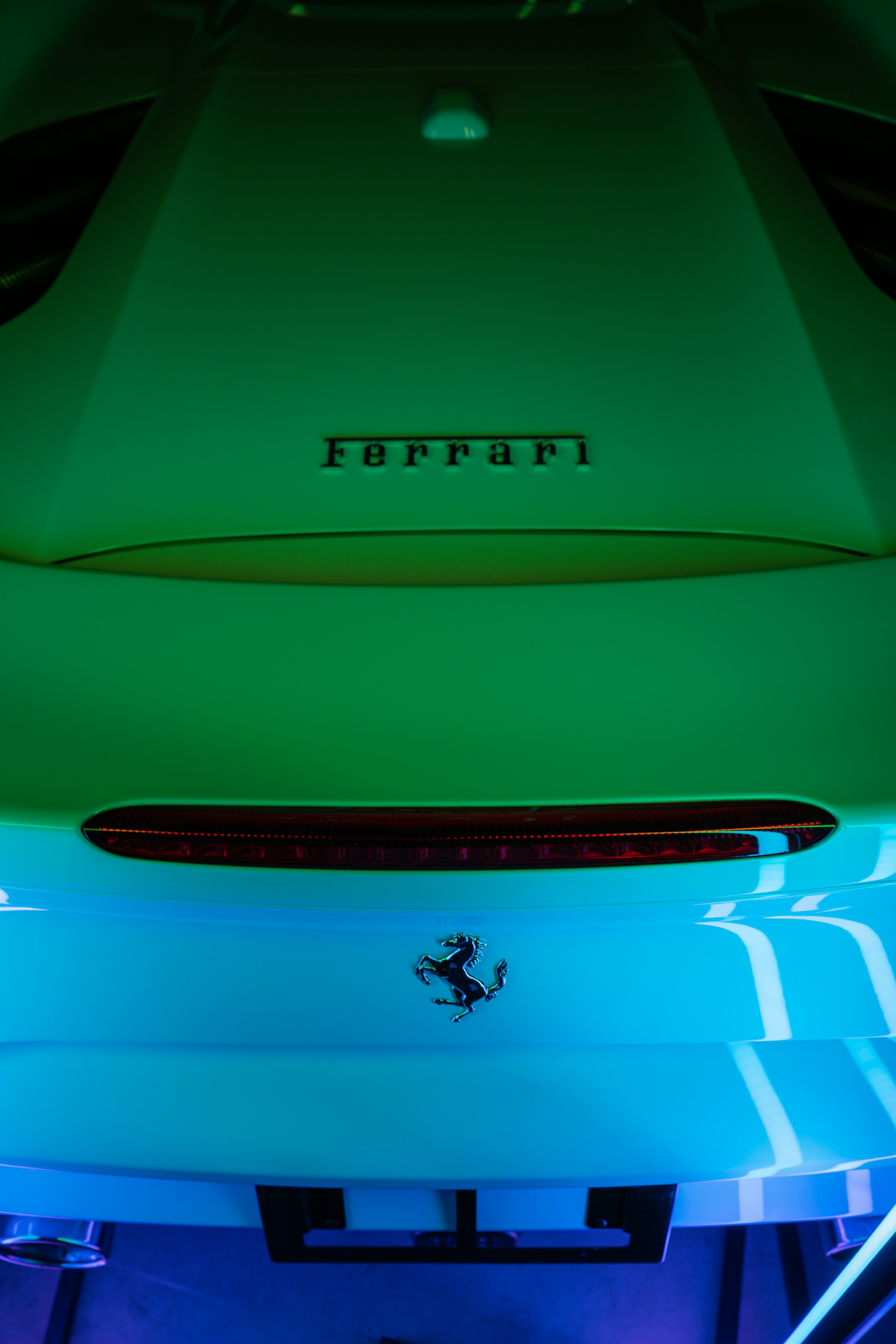 Neon Verde and Electric Azure: Ferrari Emblem in a Cyan Glow