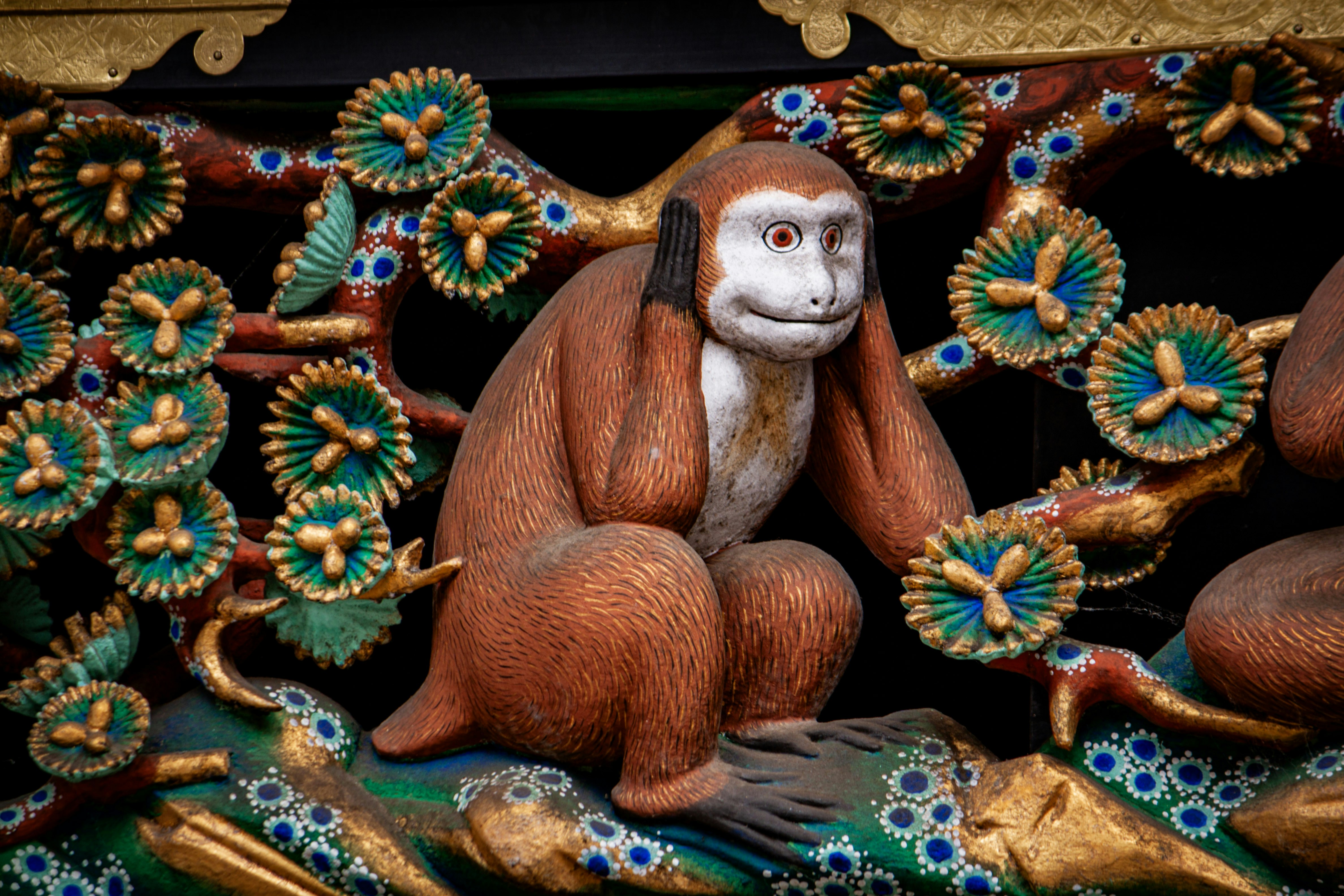 Hear-No-Evil Guardian Amid a Tapestry of Gold and Teal Florals