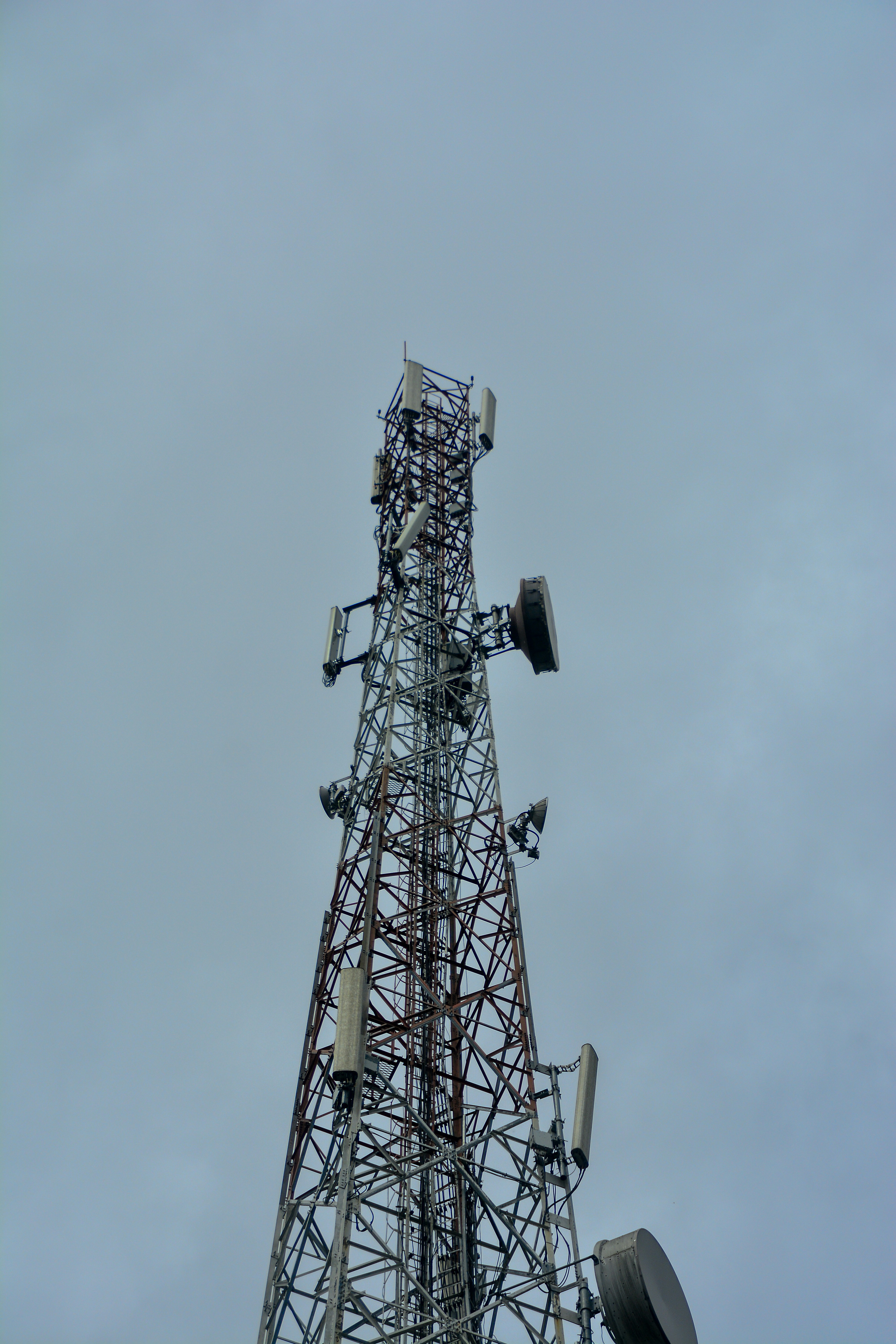 A very tall tower with a lot of antennas on top of it photo – Free ...