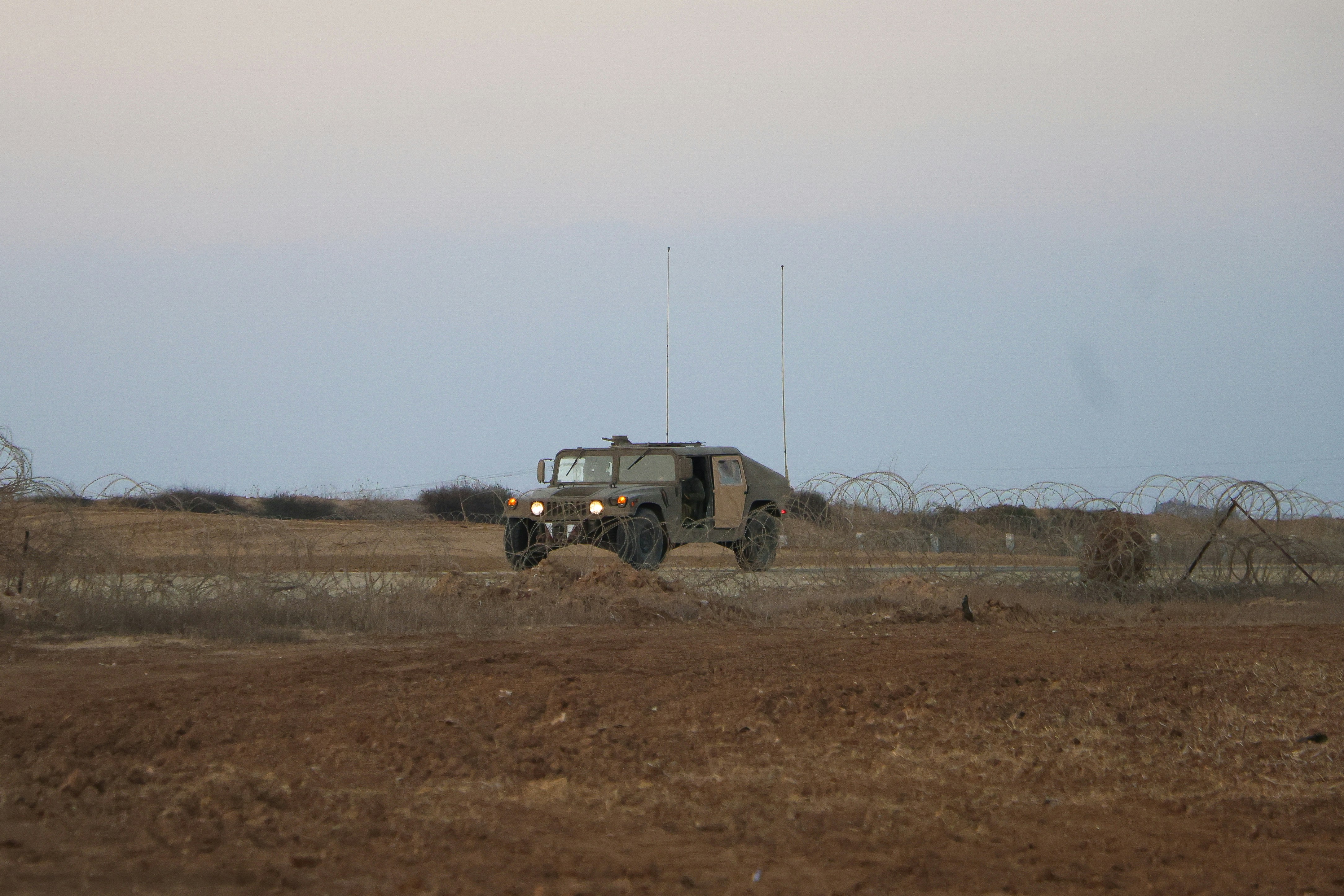 A truck driving through a dry grass field photo – Free Car Image on ...