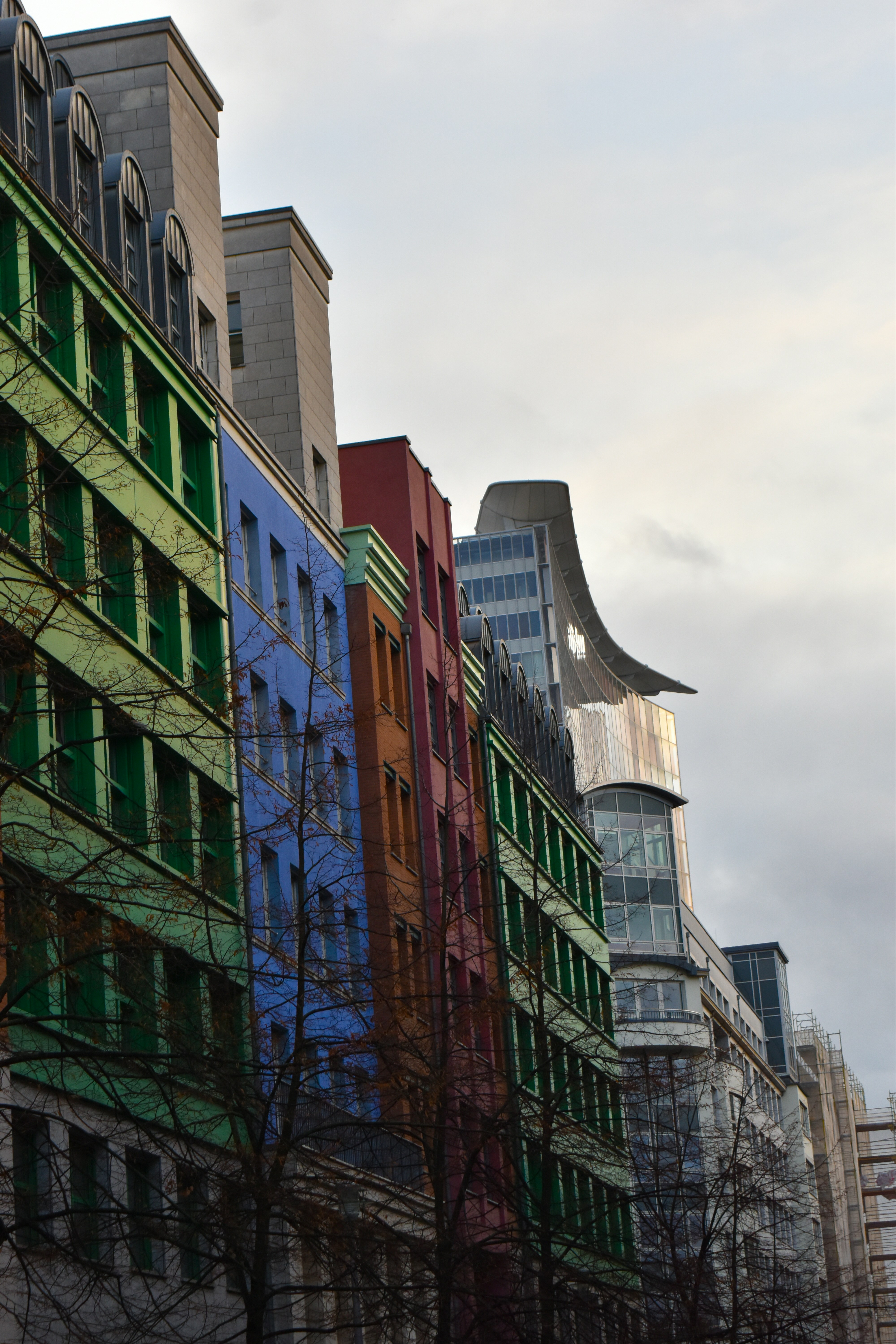 Chromatic Facade: A Rainbow Row Bends Toward the Modern Skyline