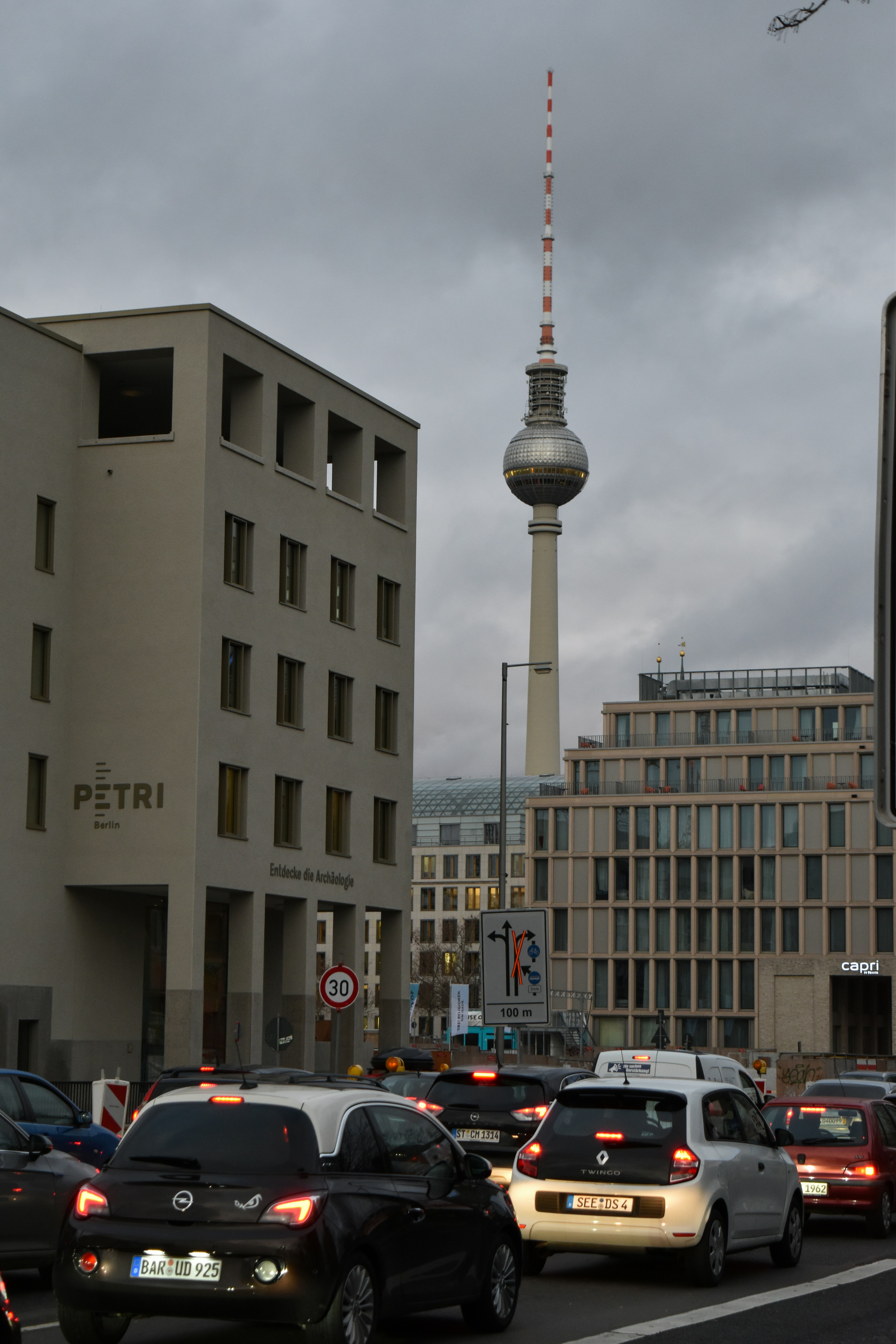 Rush Hour Under a Cloudy Berlin Skyline: TV Tower Pierces the Grey
