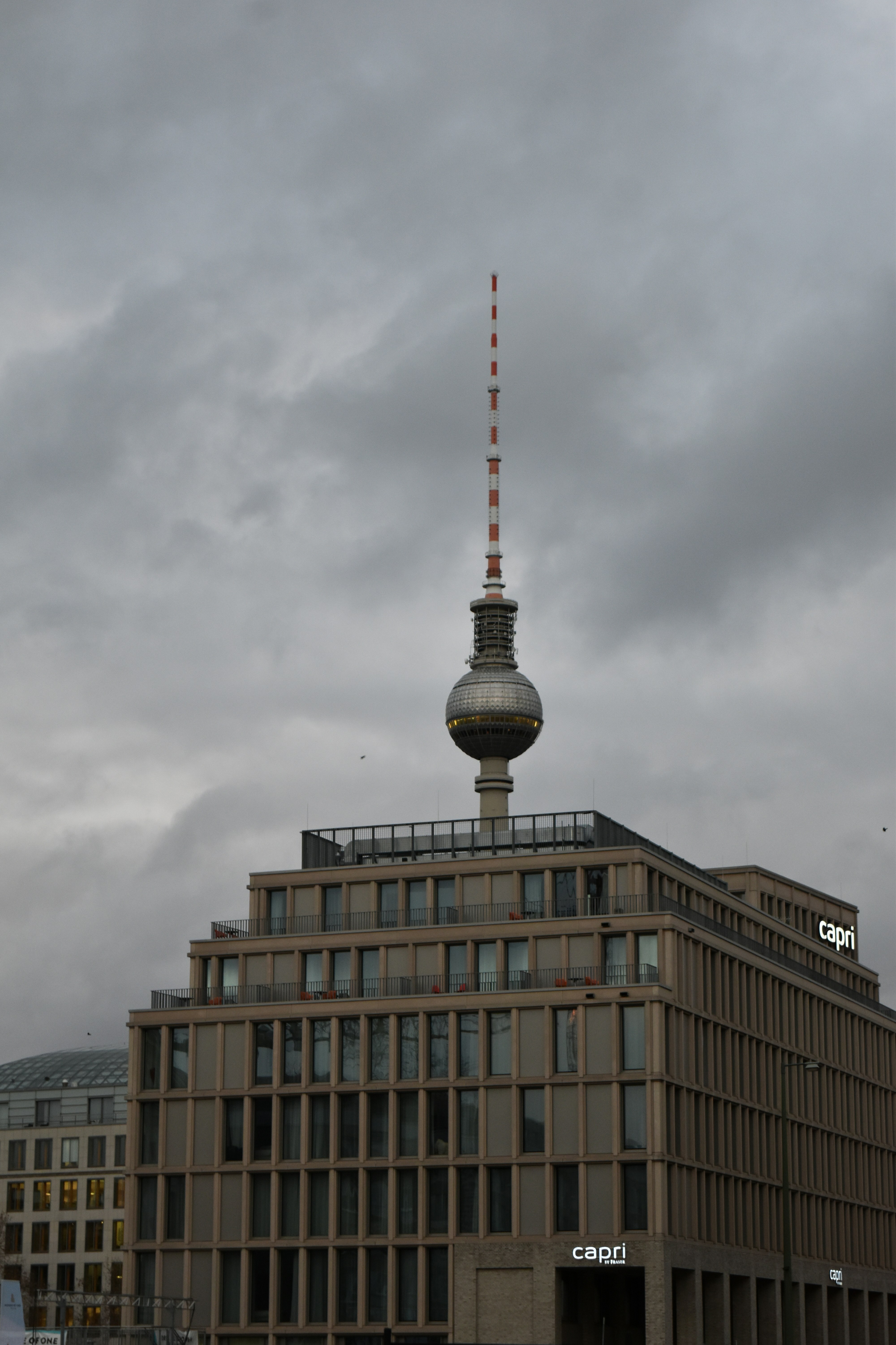 Antenna Crown Over a Brick Campus Under a Brooding Sky