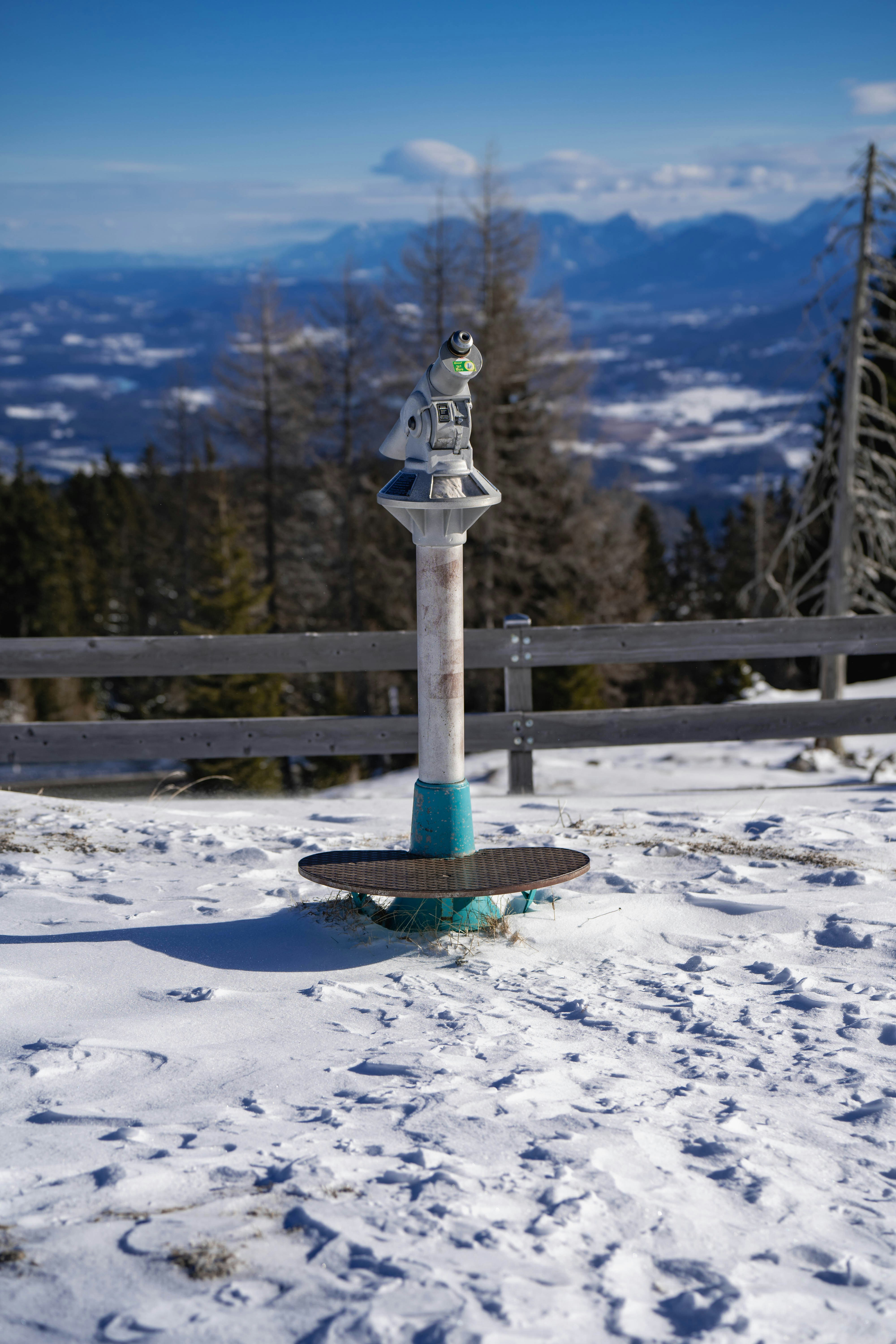 Coin-Operated Summit Viewer Framed by Snow and Pines